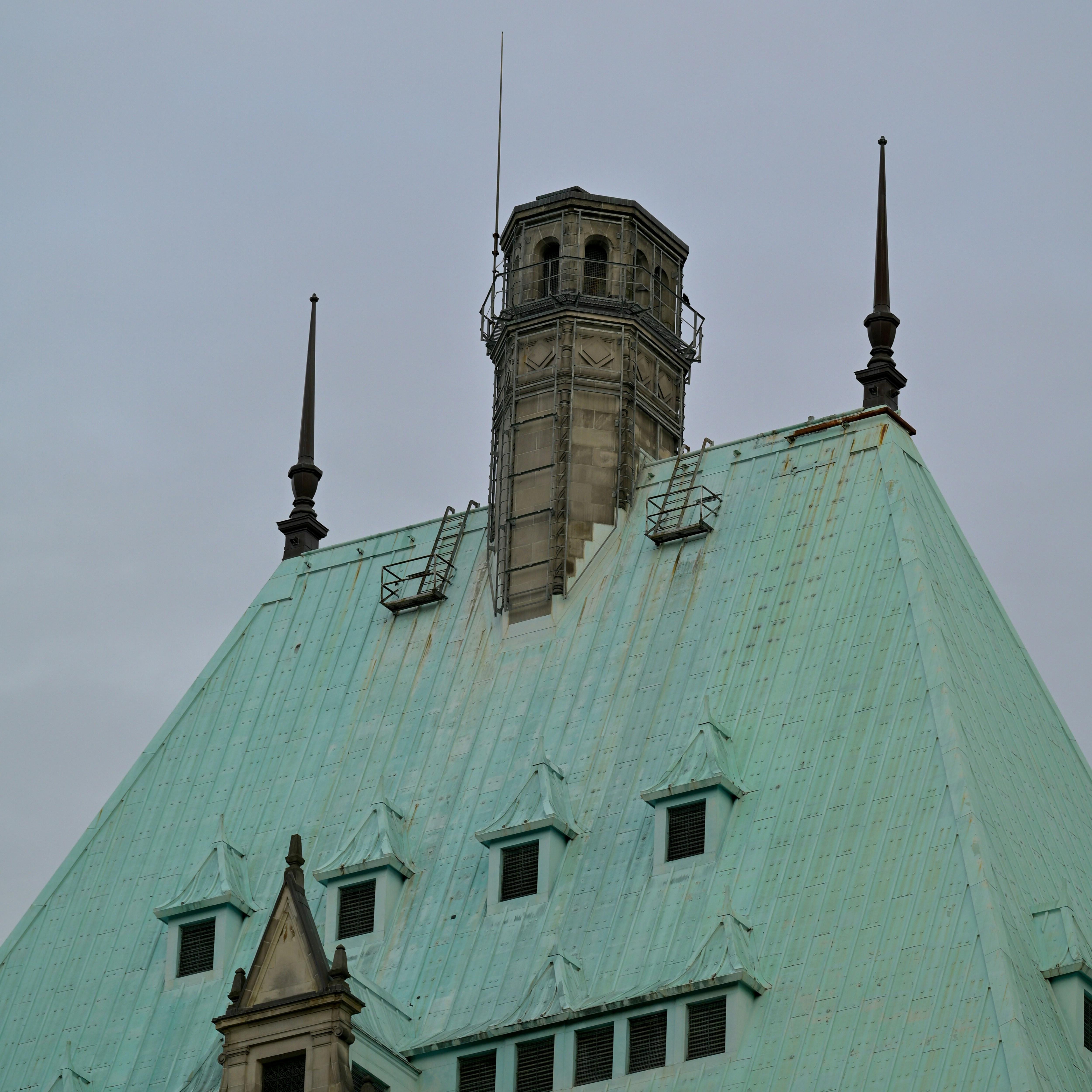 Copper Roofed Cathedral: A Vertical View Under an Overcast Sky