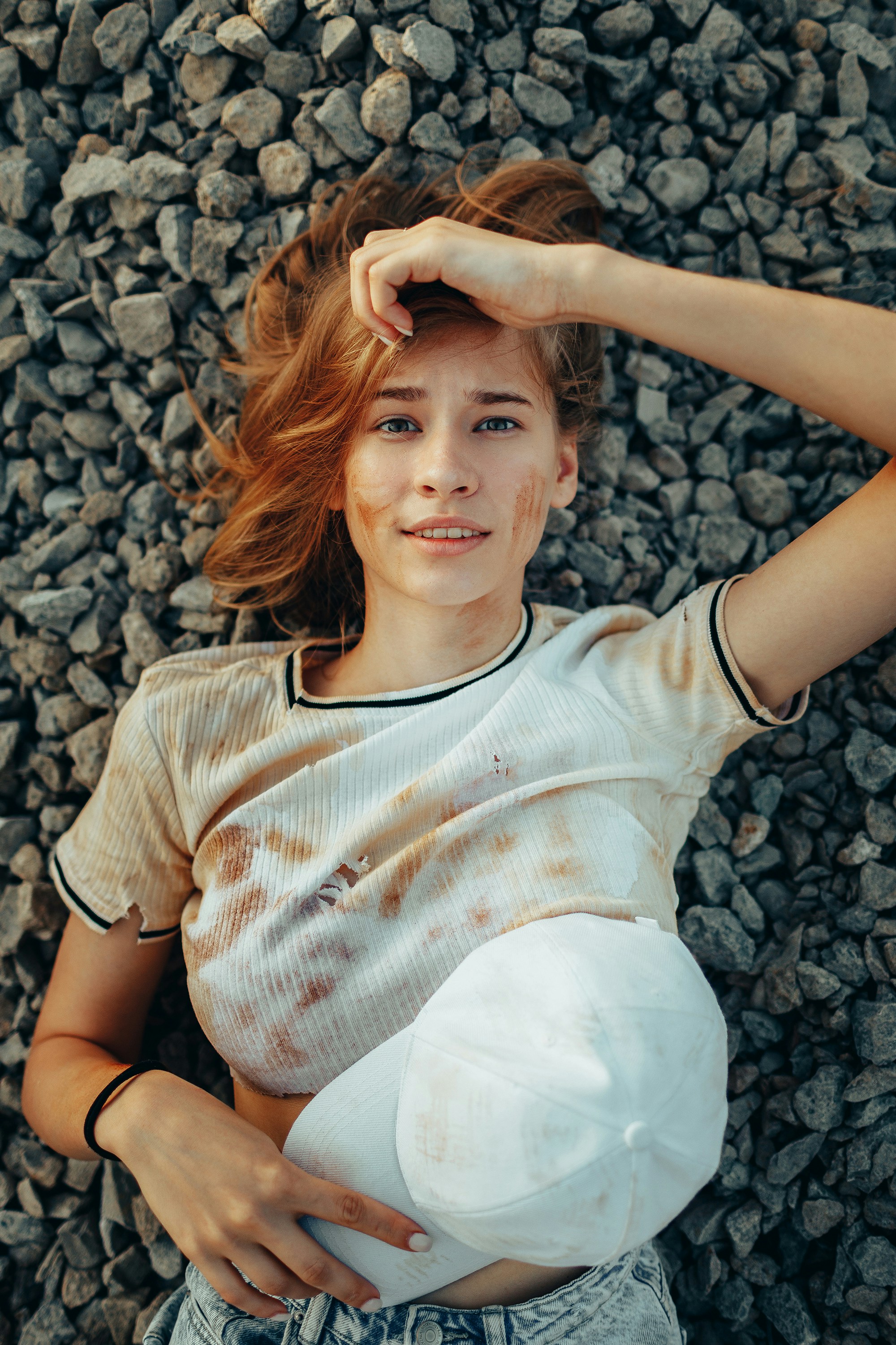 Stranded in Pebbled Light: A Quiet Portrait under Shifting Hands