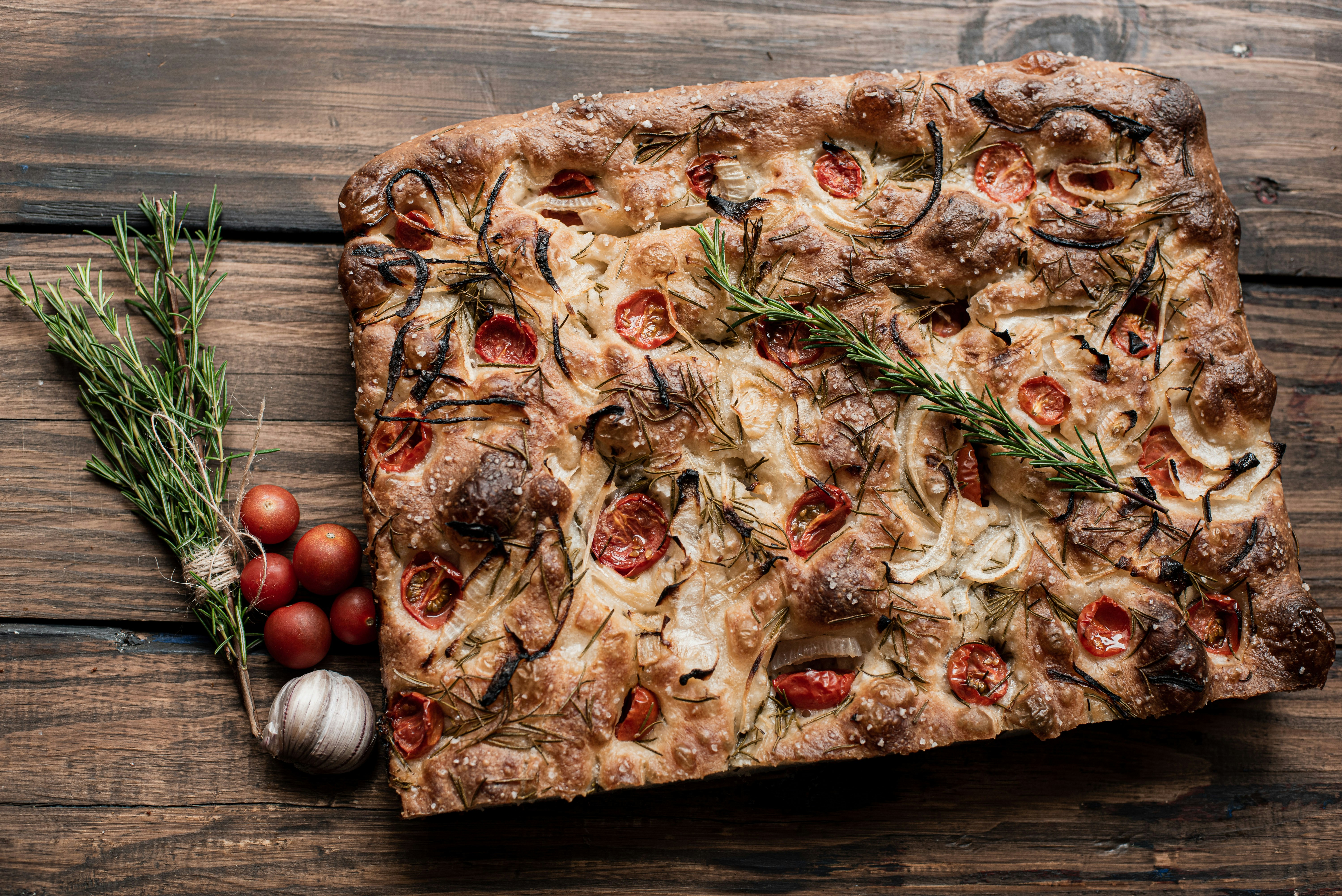 Herbed Fanned Flatbread: Cherry Tomatoes and Sprigs on Rustic Wood