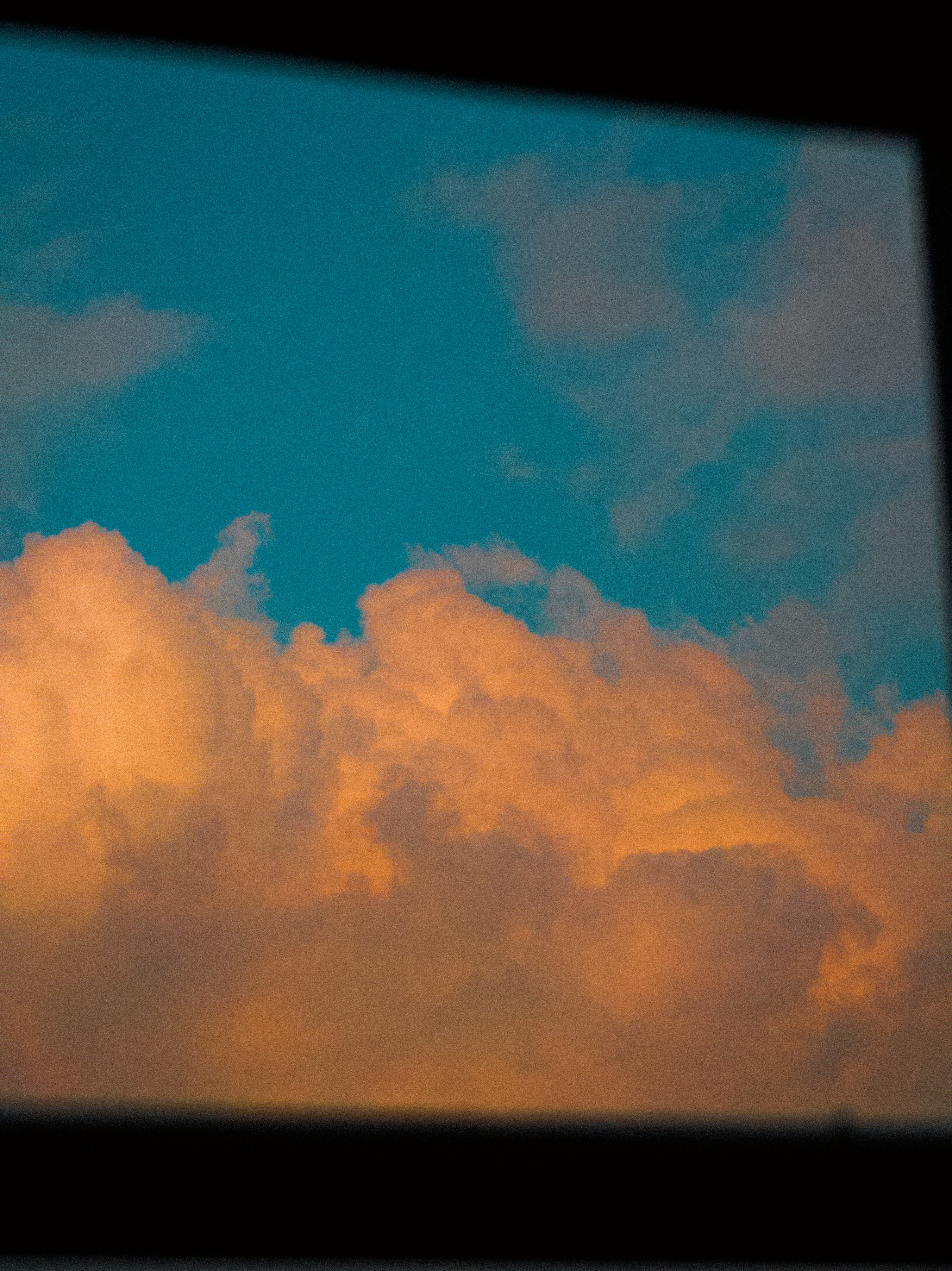 Orange clouds against a bright blue sky