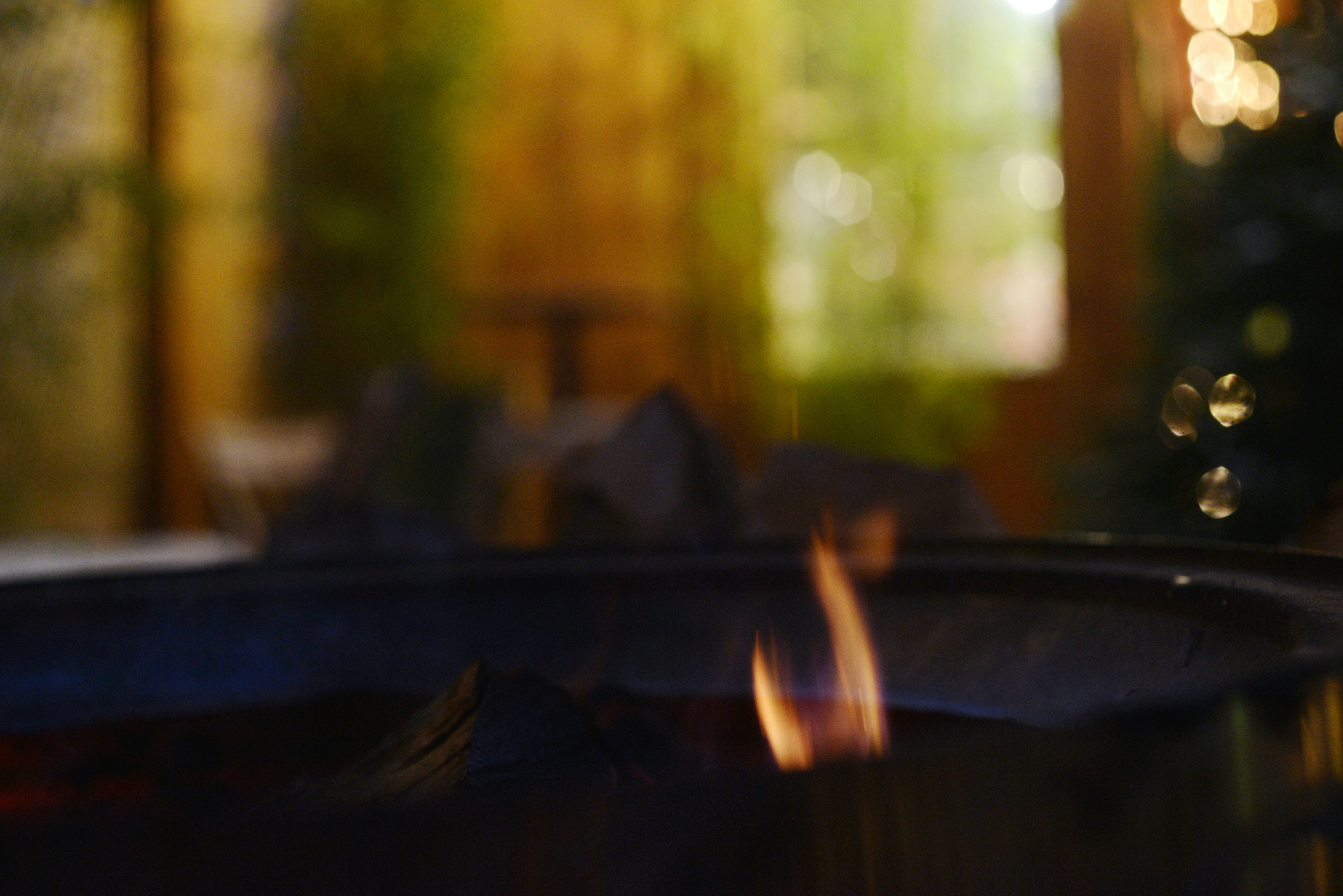 Flame in Focus Beyond the Blurred Lounge