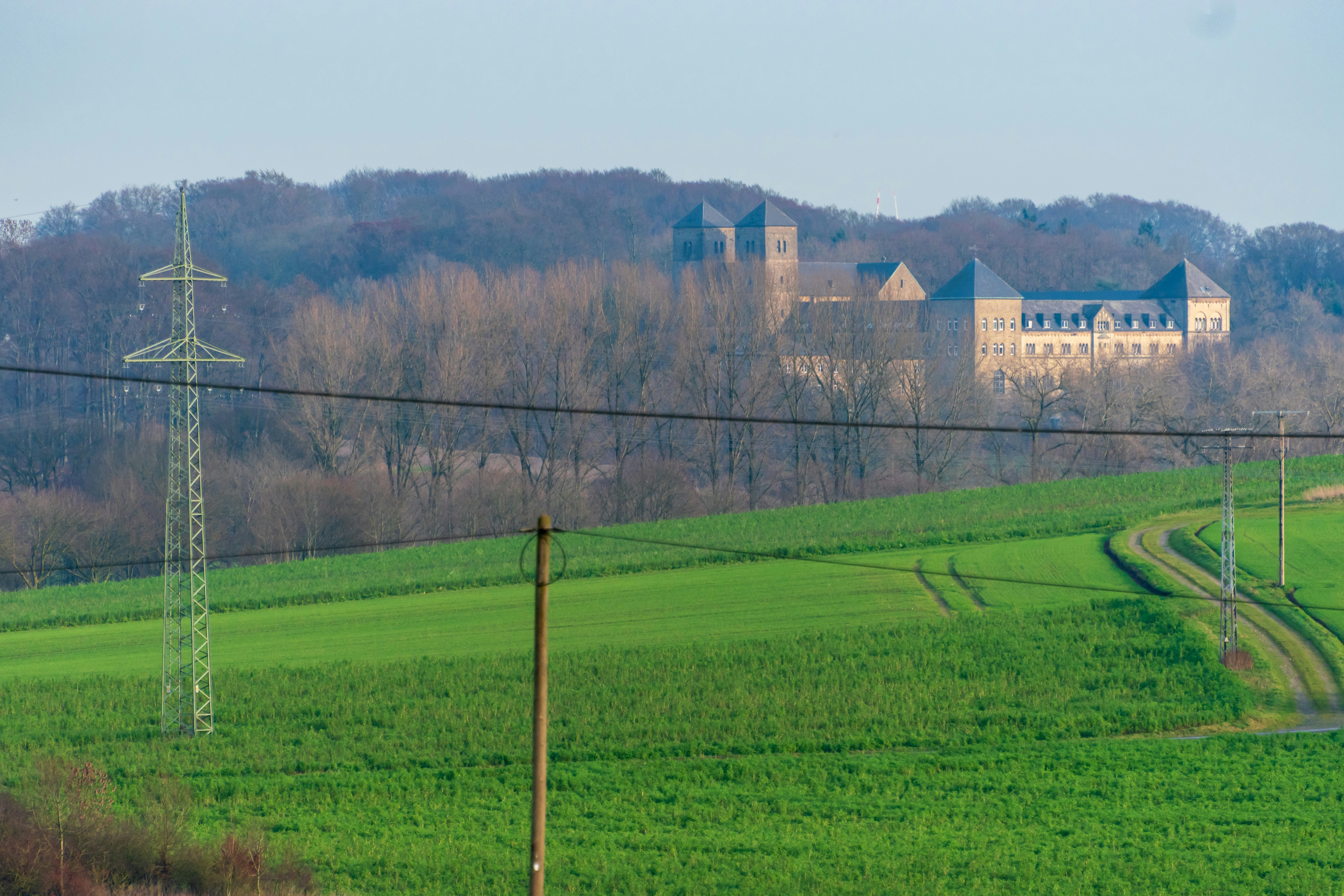 Ancient Keep on the Hill: Fields, Cables, and a Distant Fortress