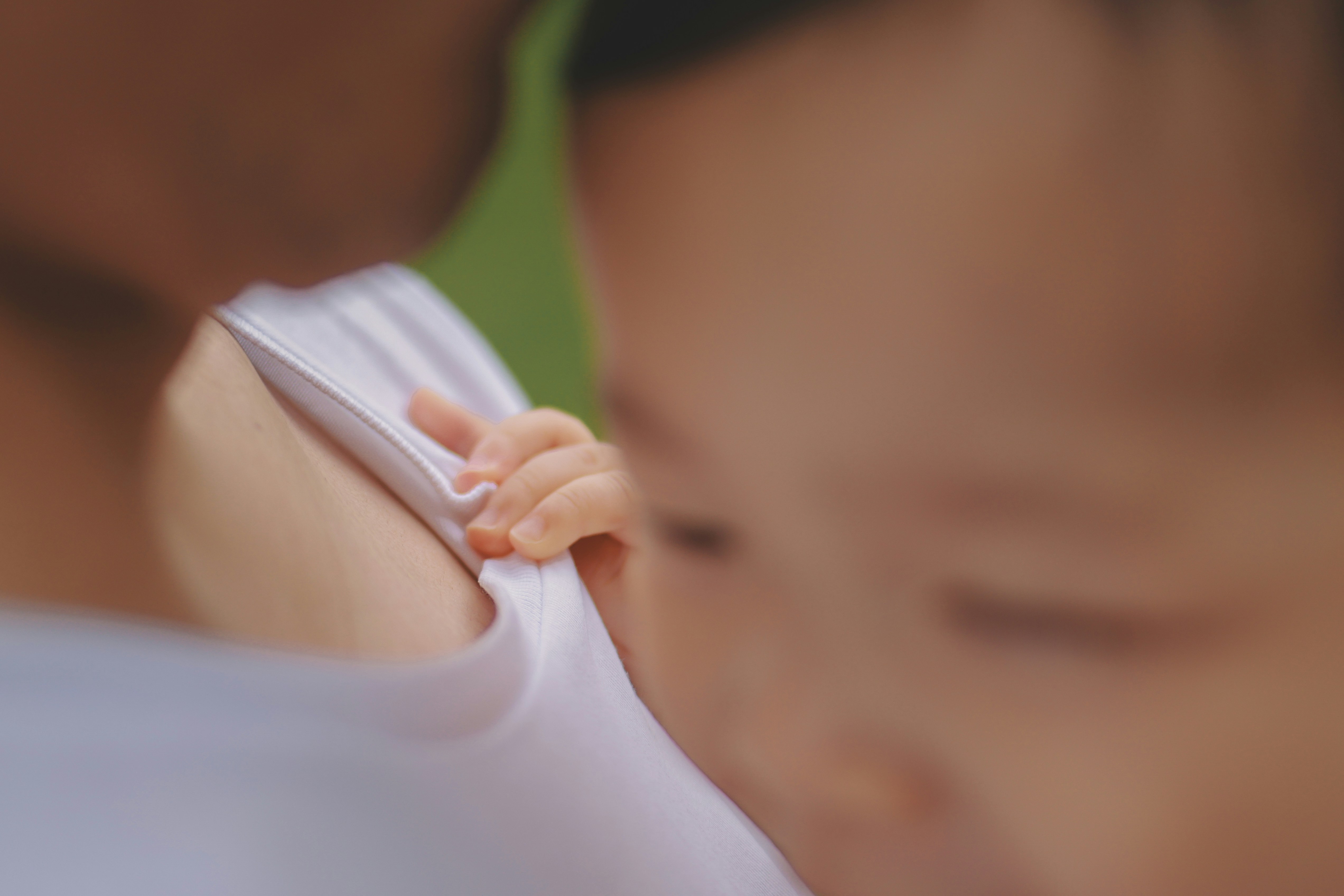 Tender Glow: The Quiet Moment of a Mother's Shoulder and Baby