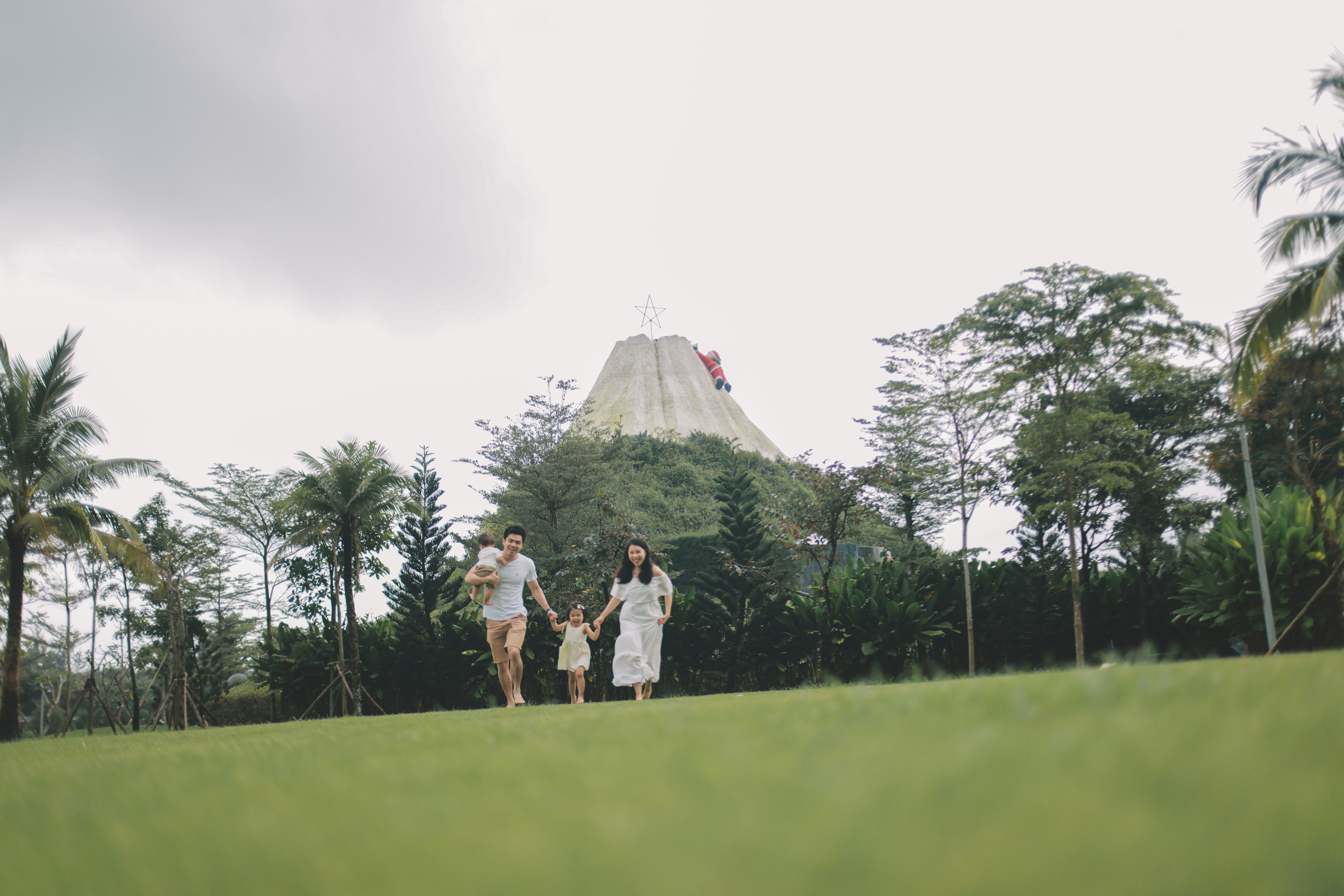 Two Wanderers Across a Sunlit Lawn with a Distant Hill