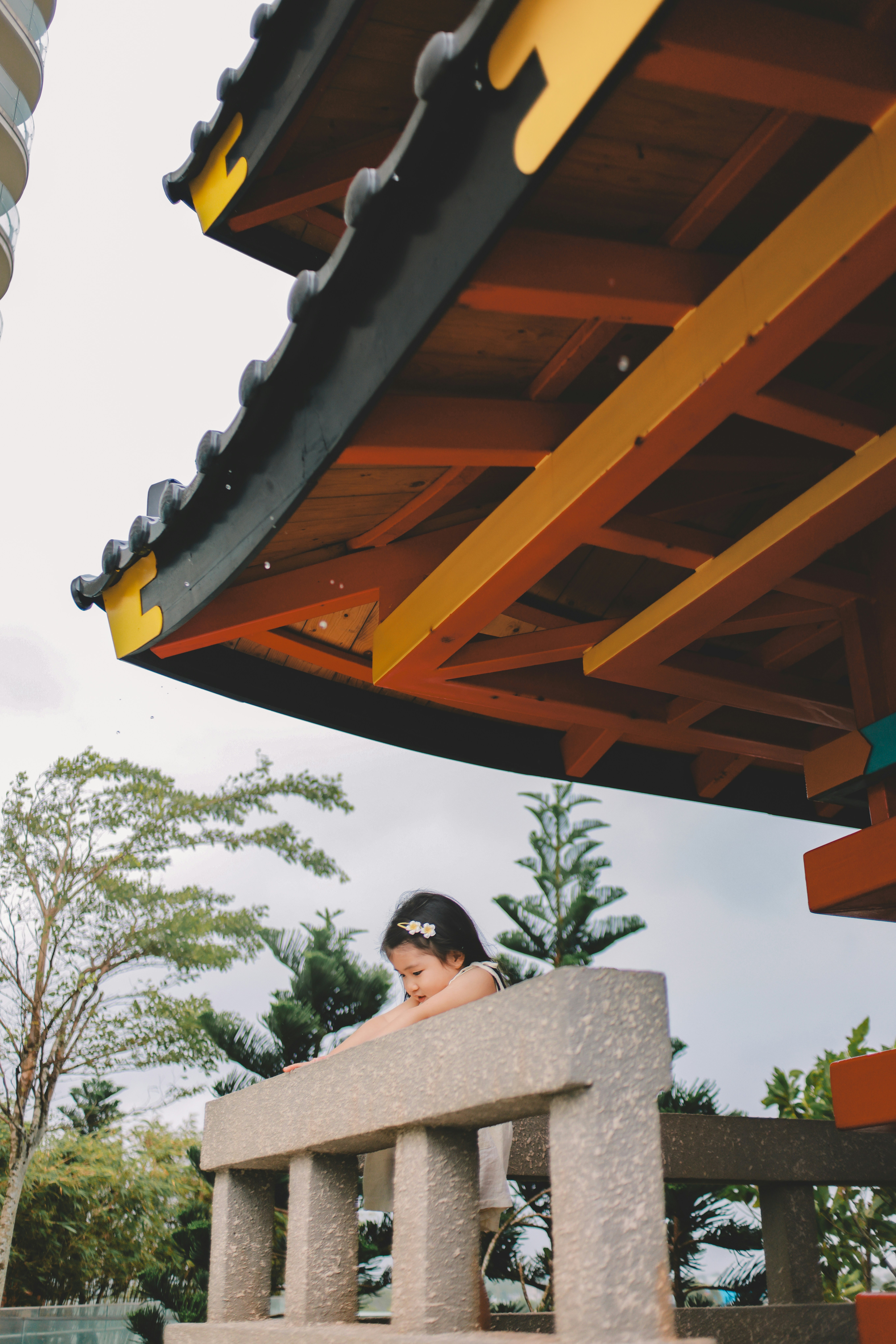 Child on a serene balcony under a decorative eave