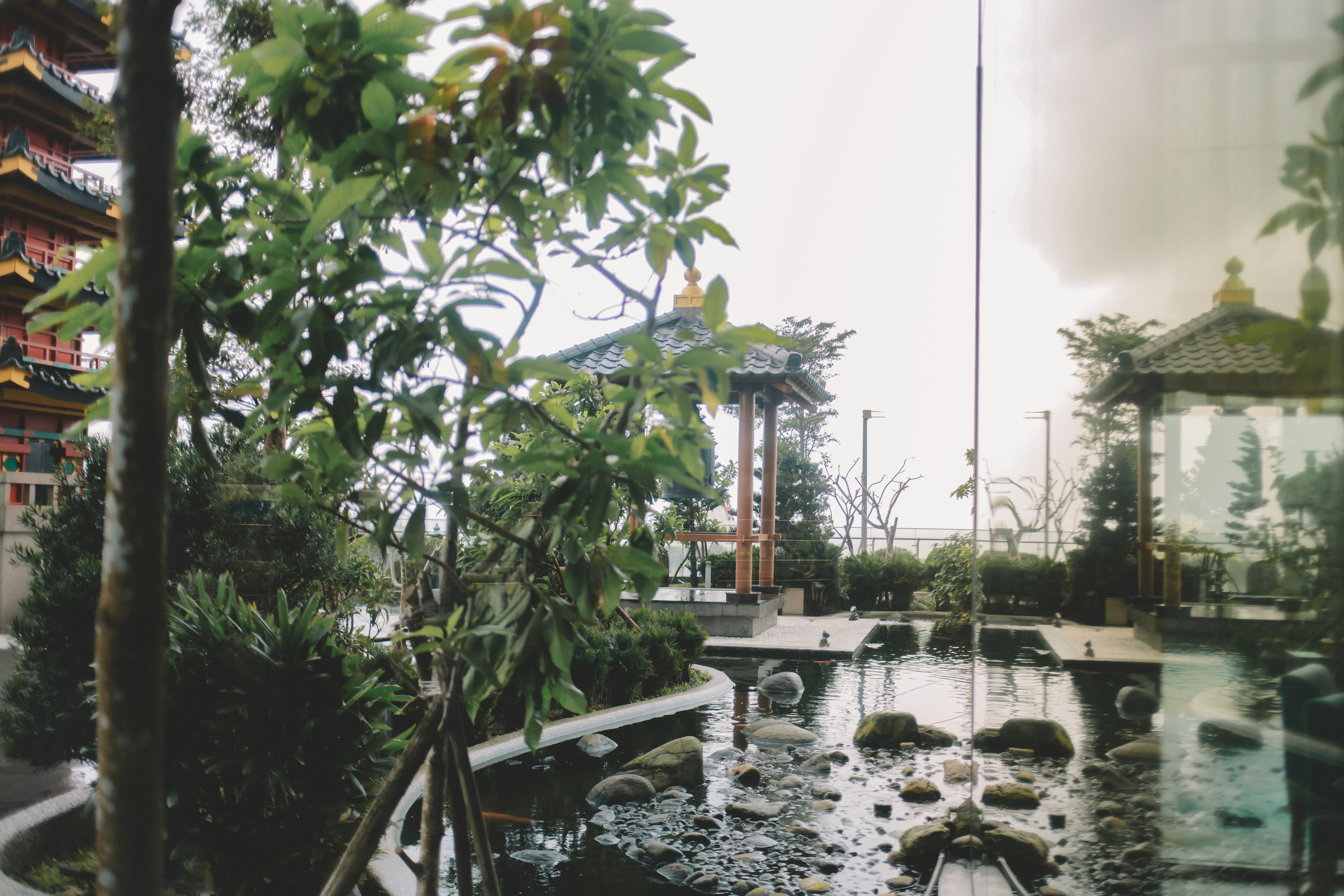 Serene courtyard with stepping stones and pavilions by a reflective pool