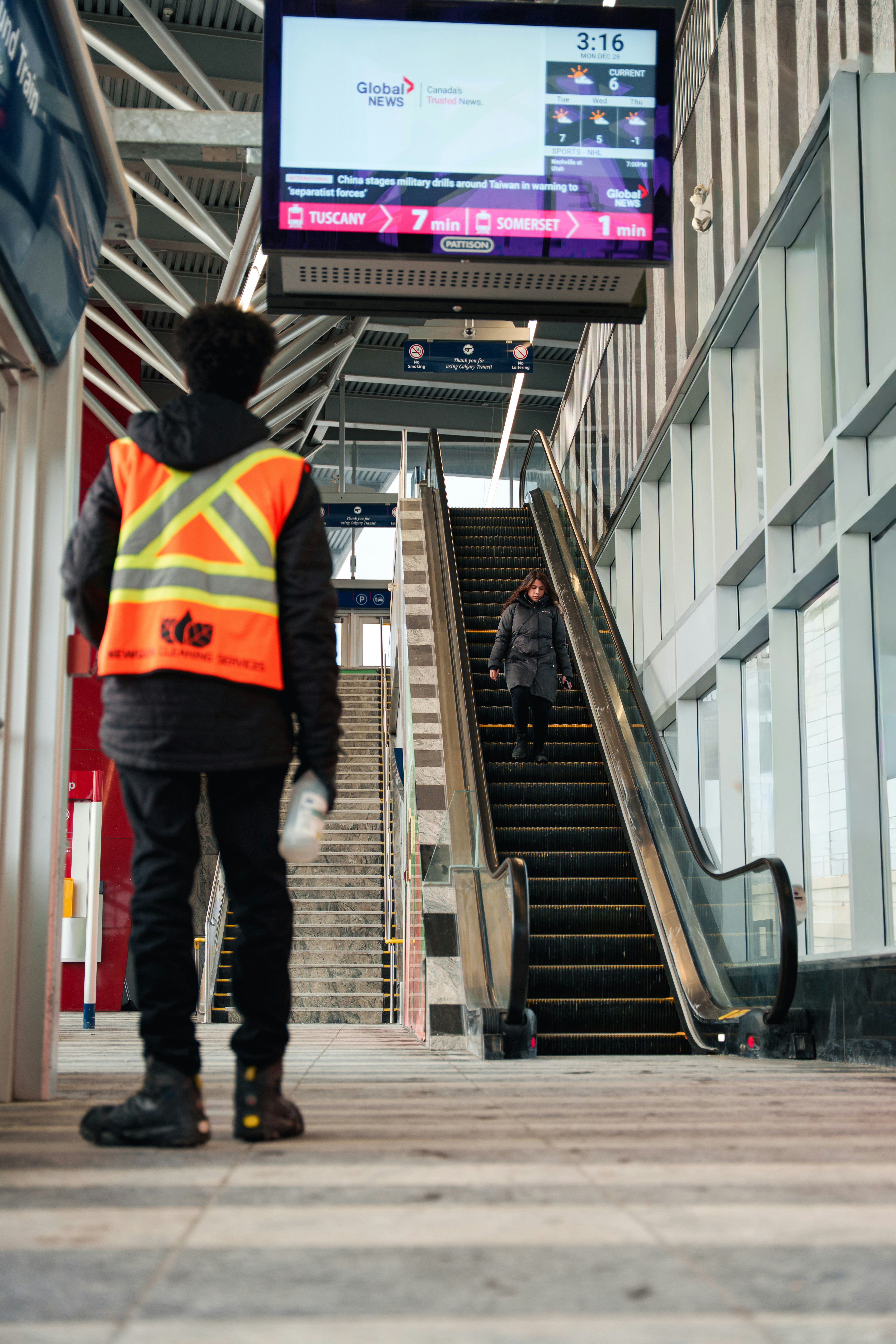 Passageway Prompt: A Worker in Hi-Vis Foreground Enforces the Flow of a Modern Transit Hub