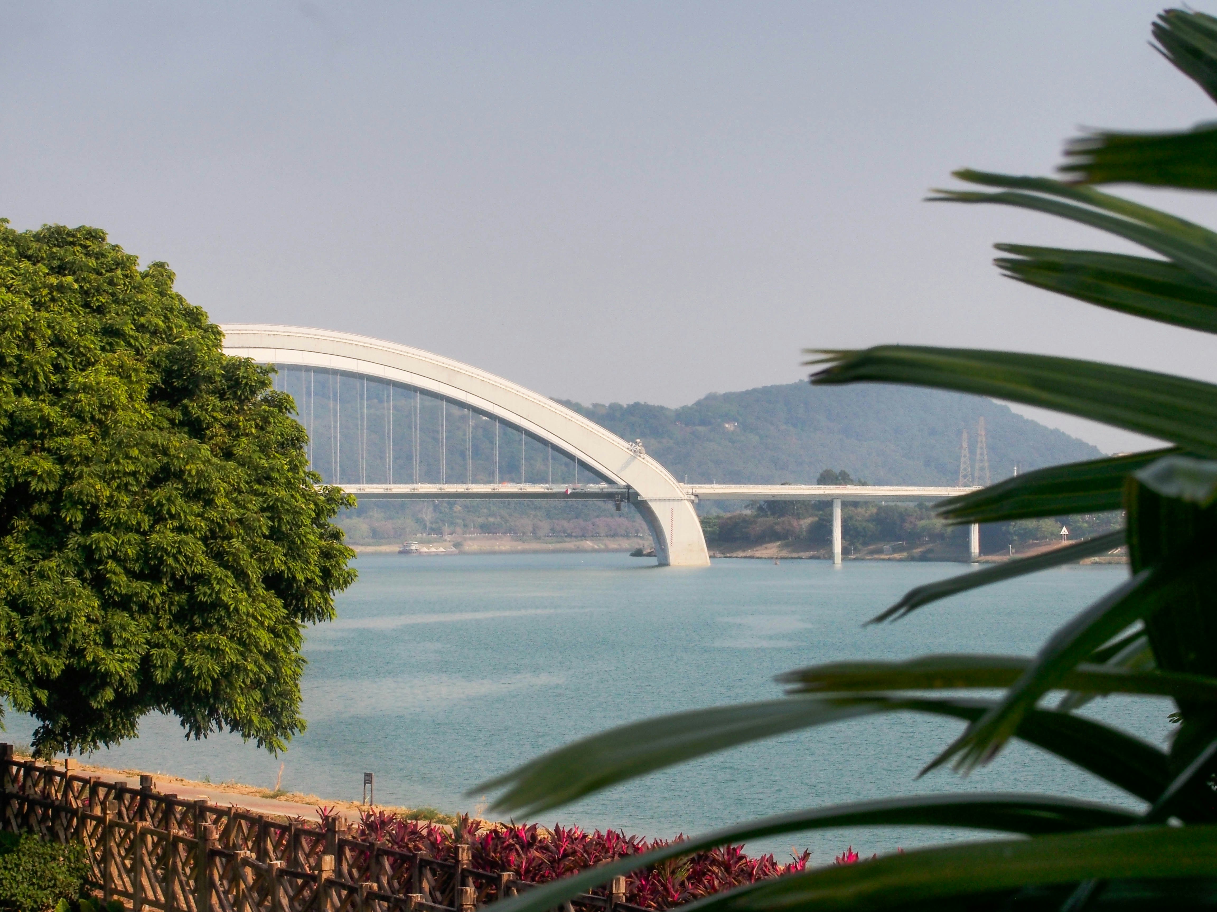 Modern bridge spanning across a wide blue river