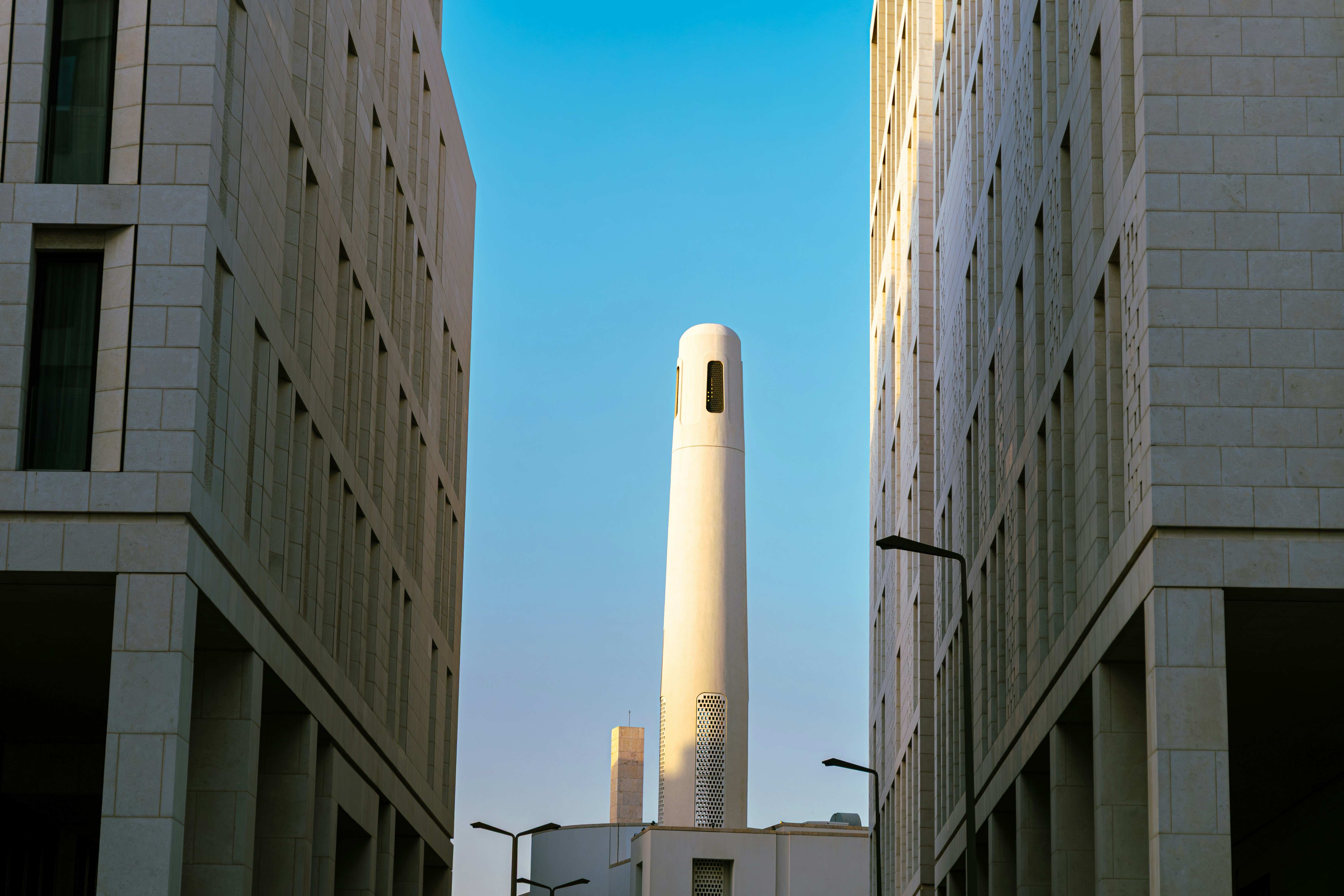Tower in the Gap: Centered Monolith Rising Between Urban Patina