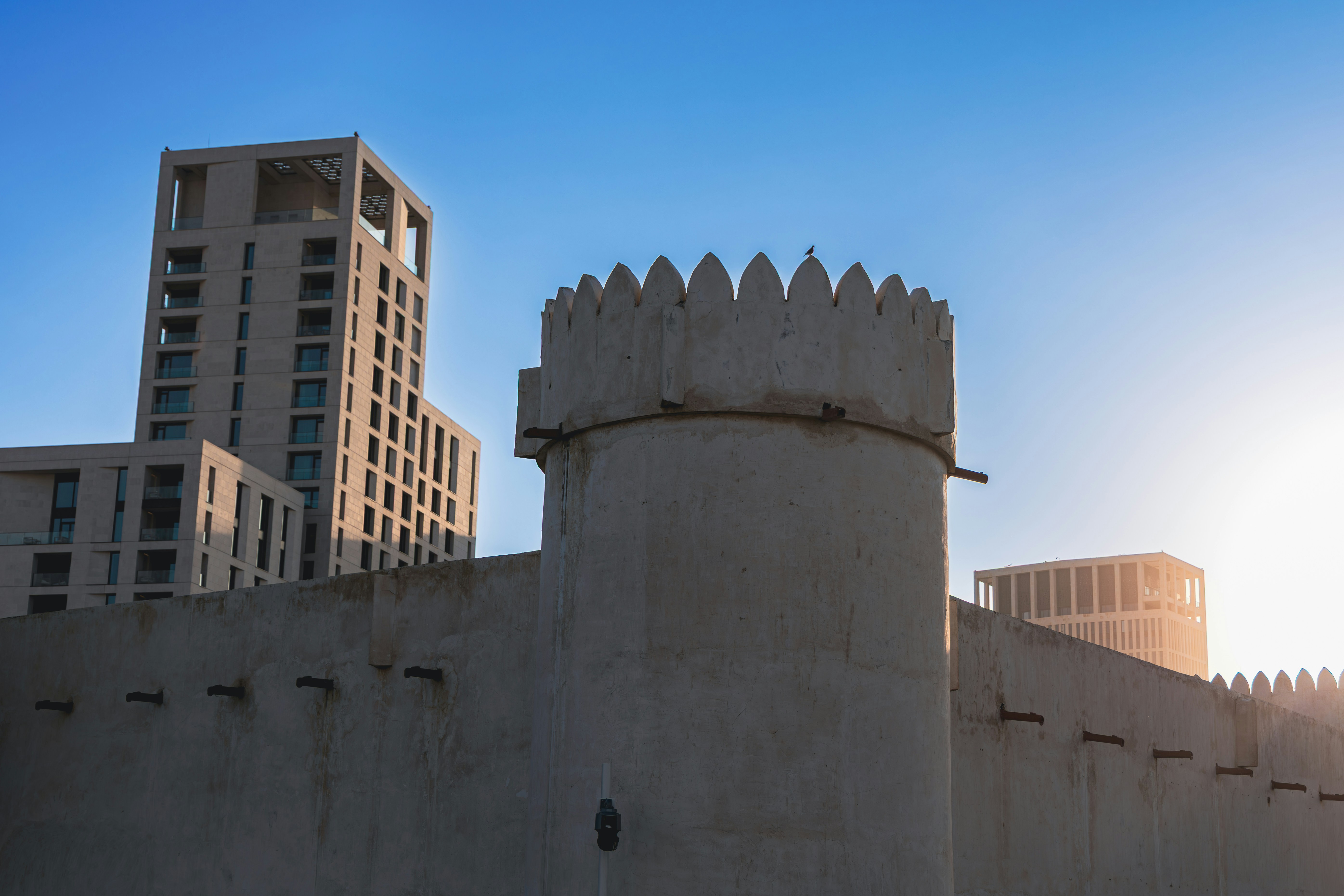 Fortified silhouette: sunlit ramparts against a modern city