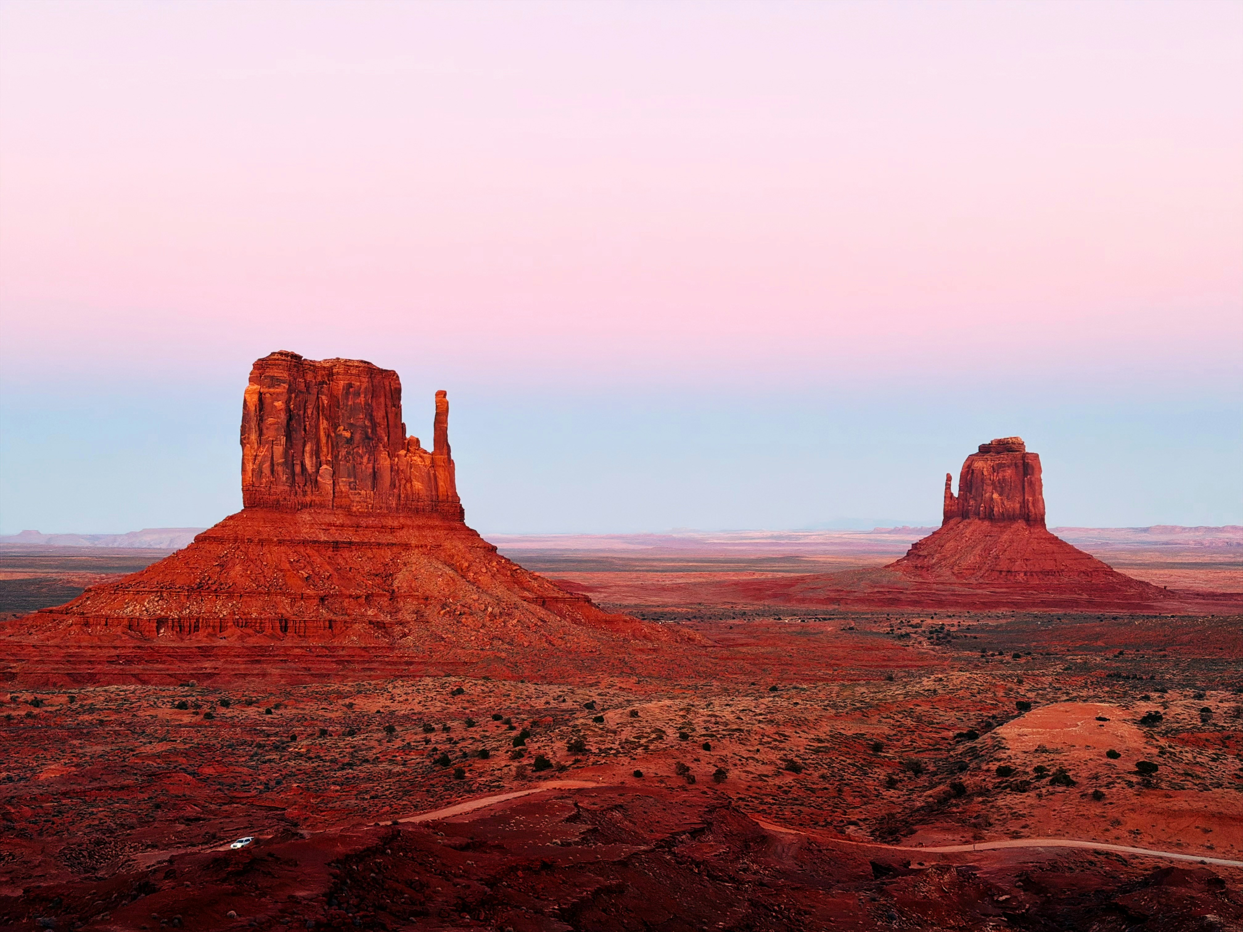 Two rock formations in a desert landscape at sunset