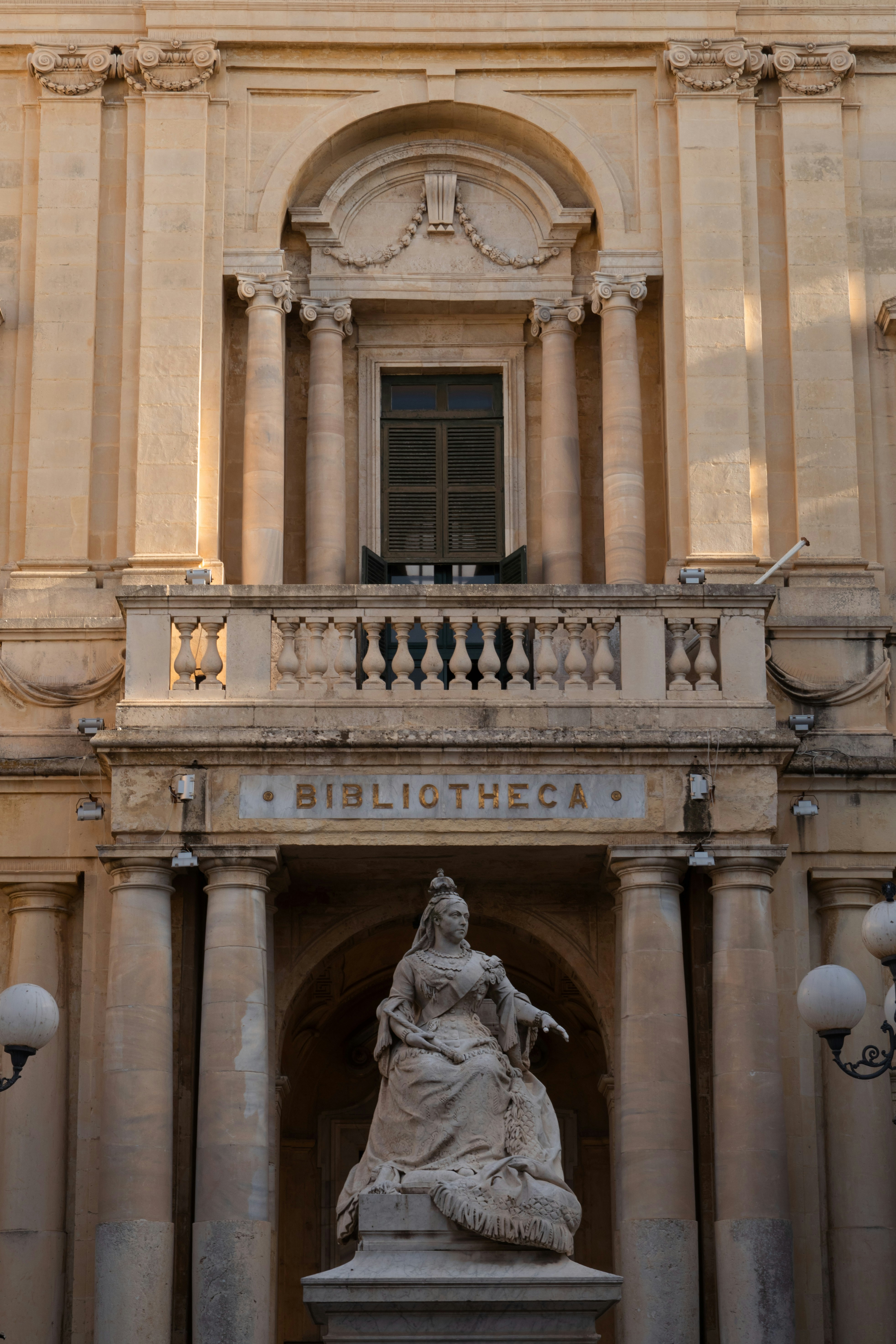 Statue Framing the Library Entrance: A Sunlit Facade