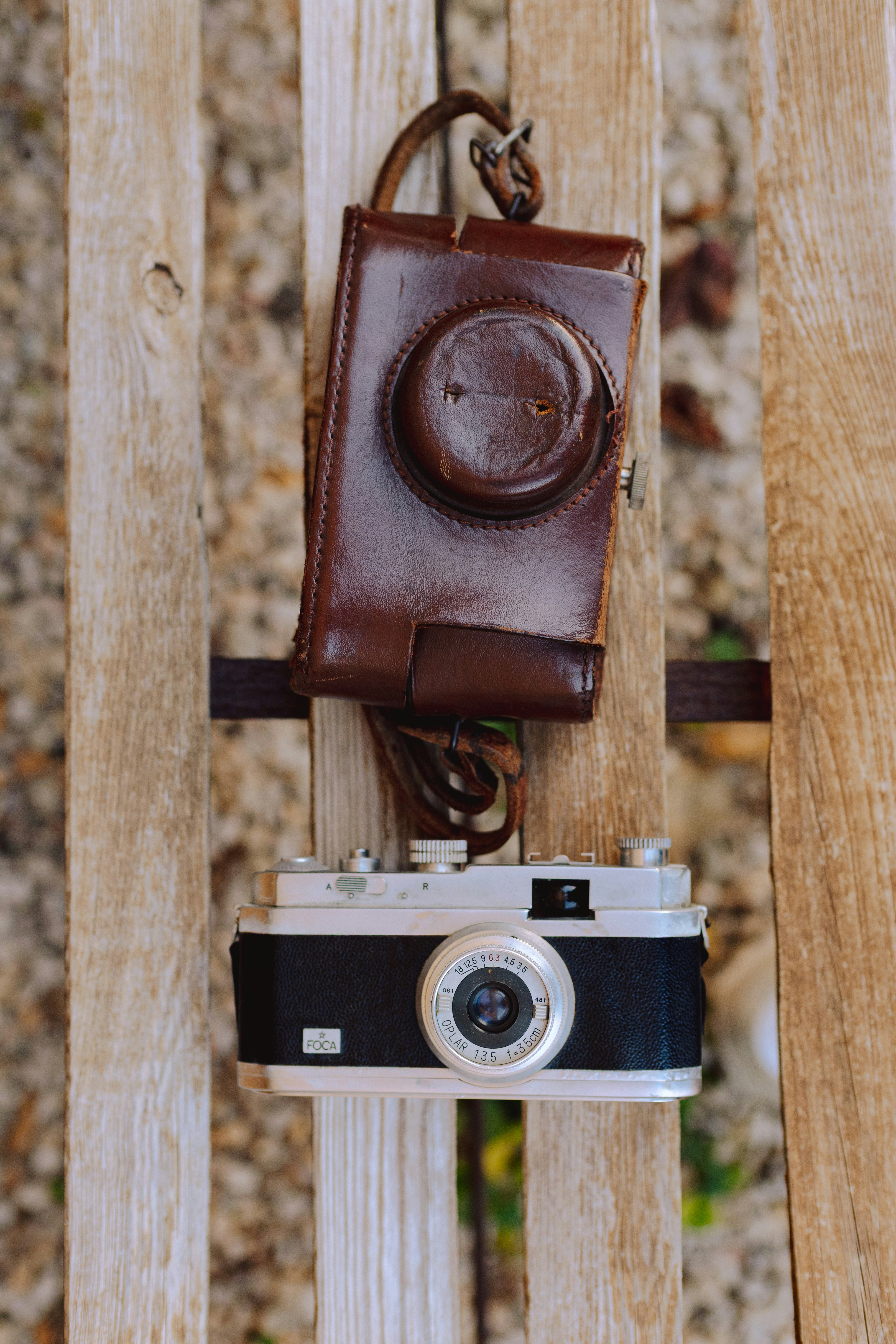 Dewdrop Lens: A Vintage Rangefinder on Weathered Planks