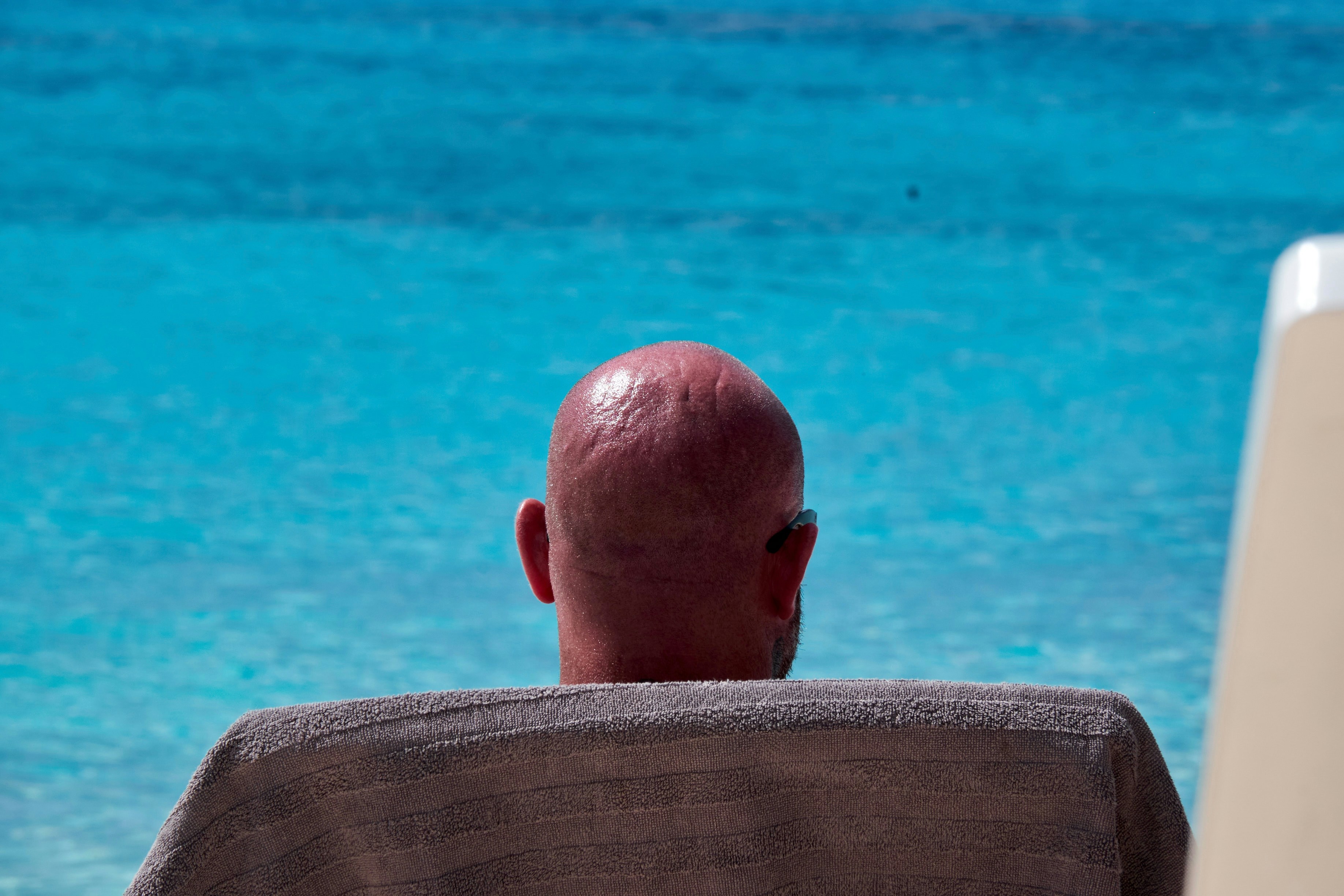 Head in the Sun: A Silhouette Against Turquoise Seas
