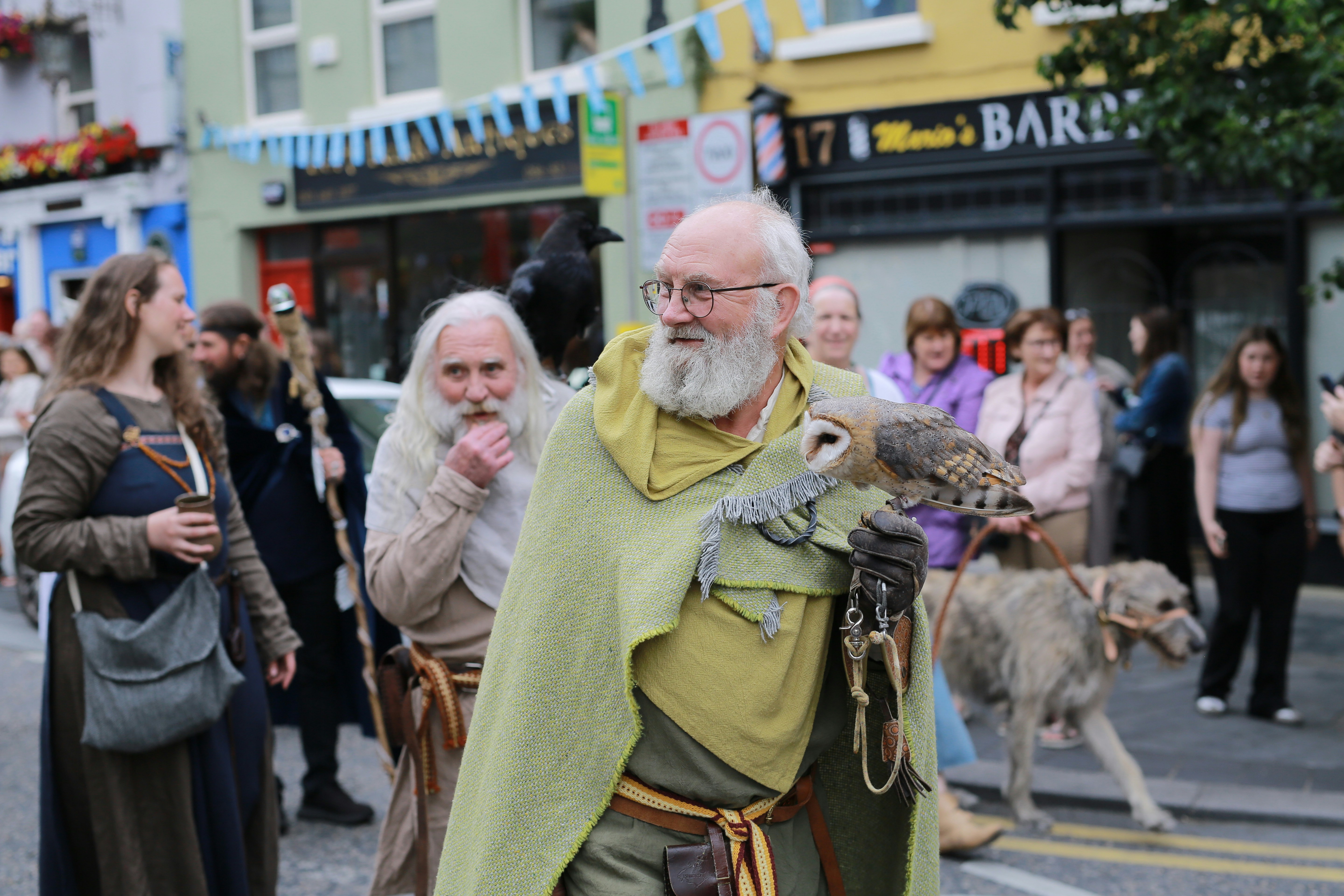 Medieval wanderer with hawk on a bustling street