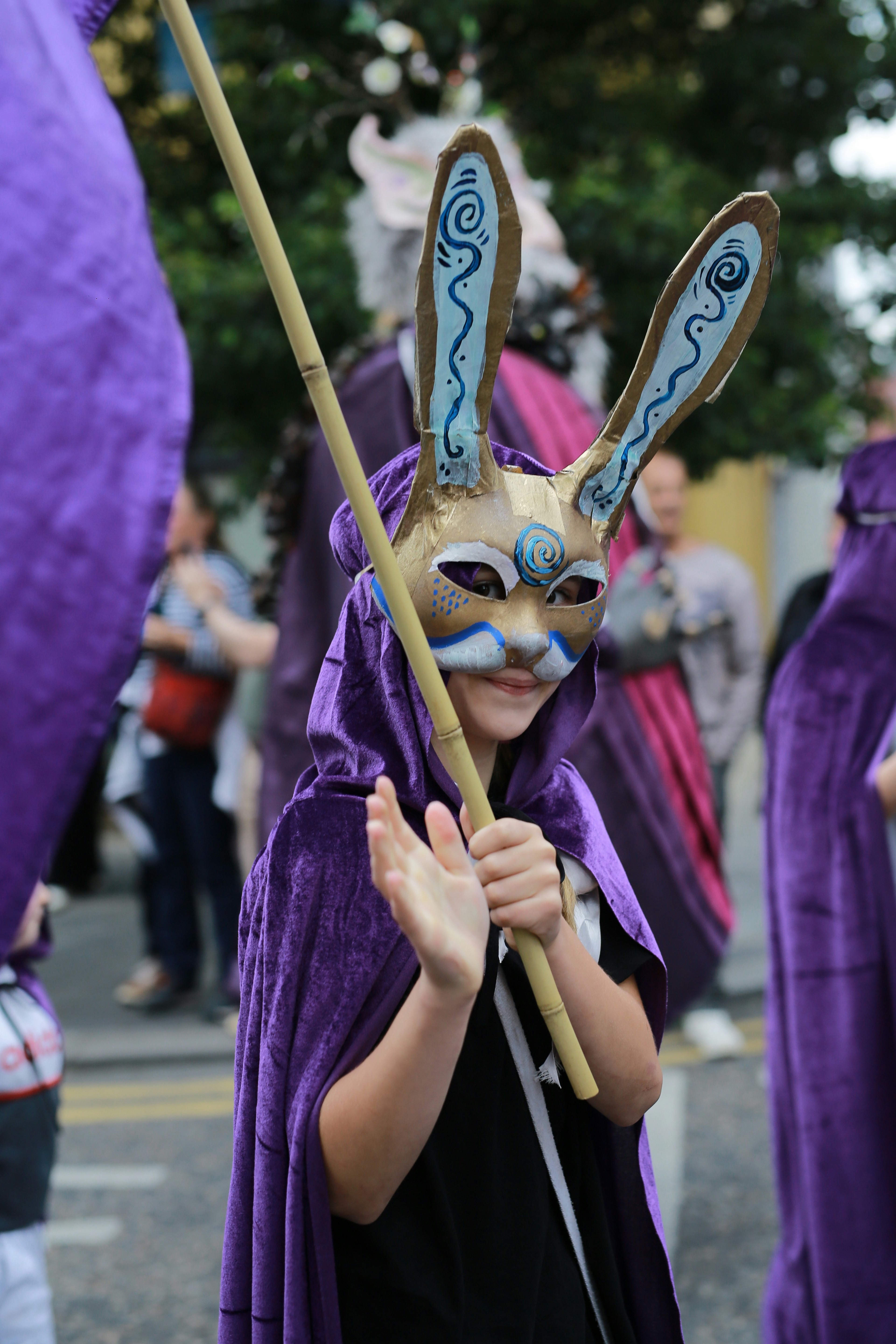 Masked Bunny Parade: Purple Cloaks and Stick Parade