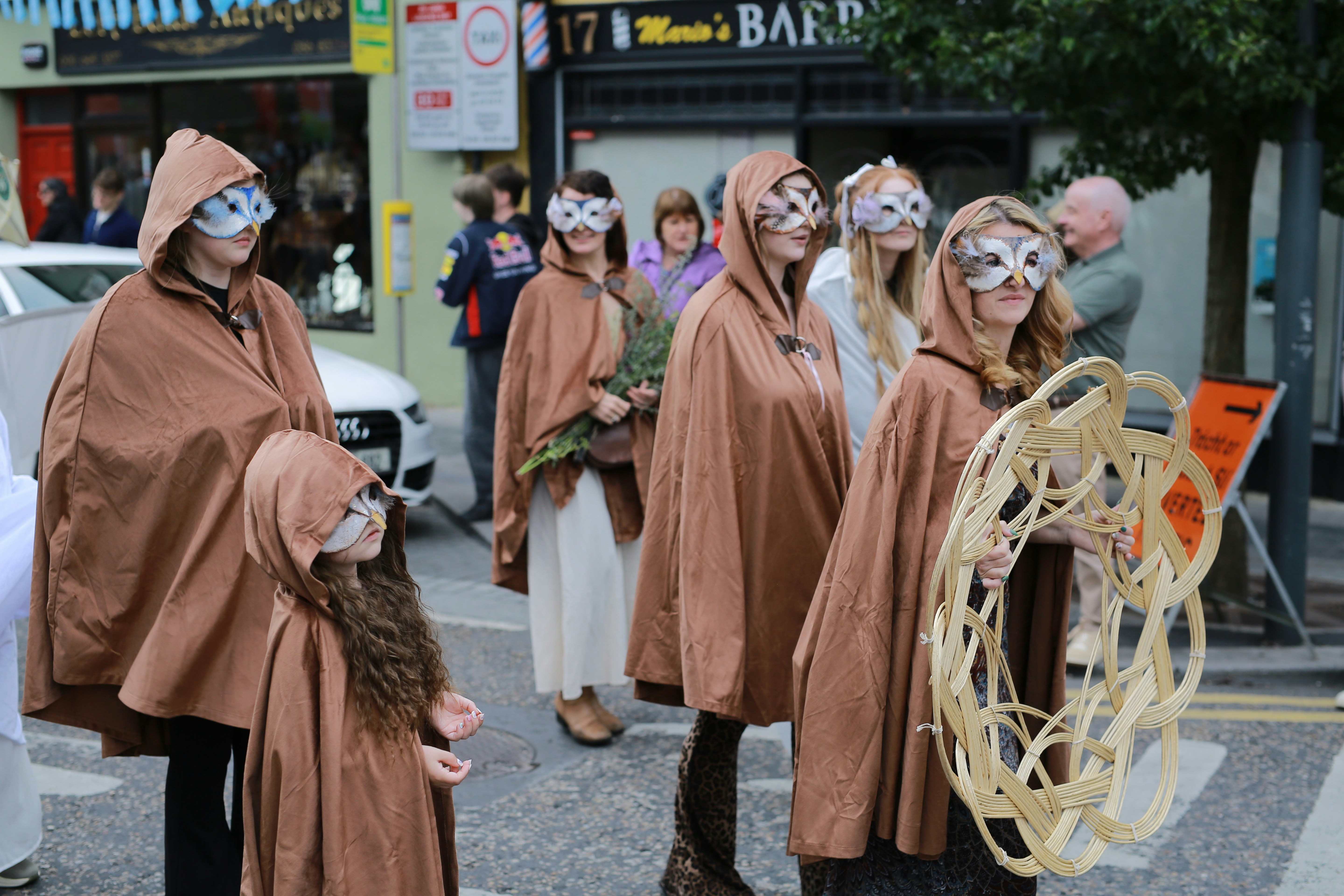 Mummers in Cloak and Mask: A Street Parade of Brown Hoods