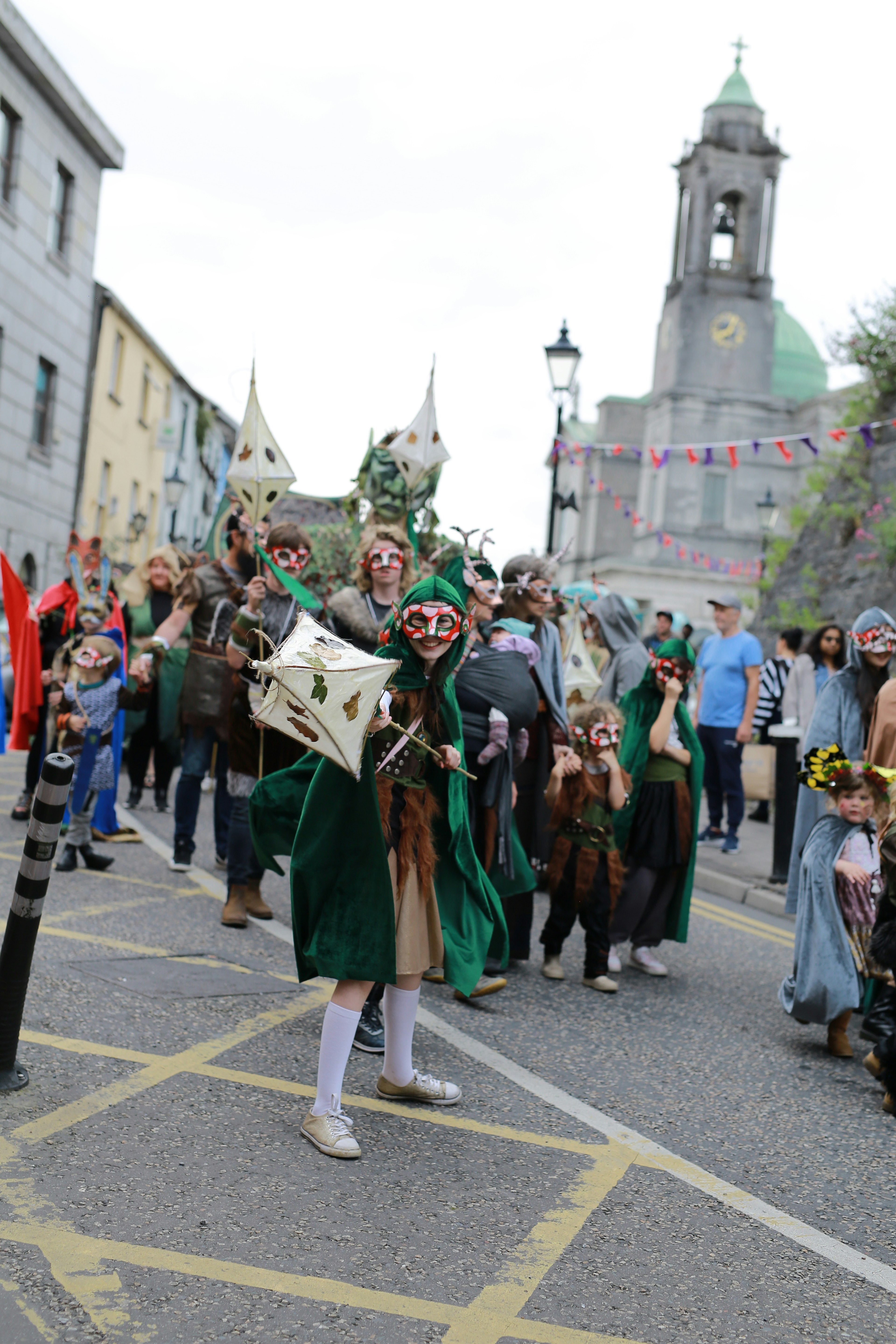 Masked parade in a sunlit town square