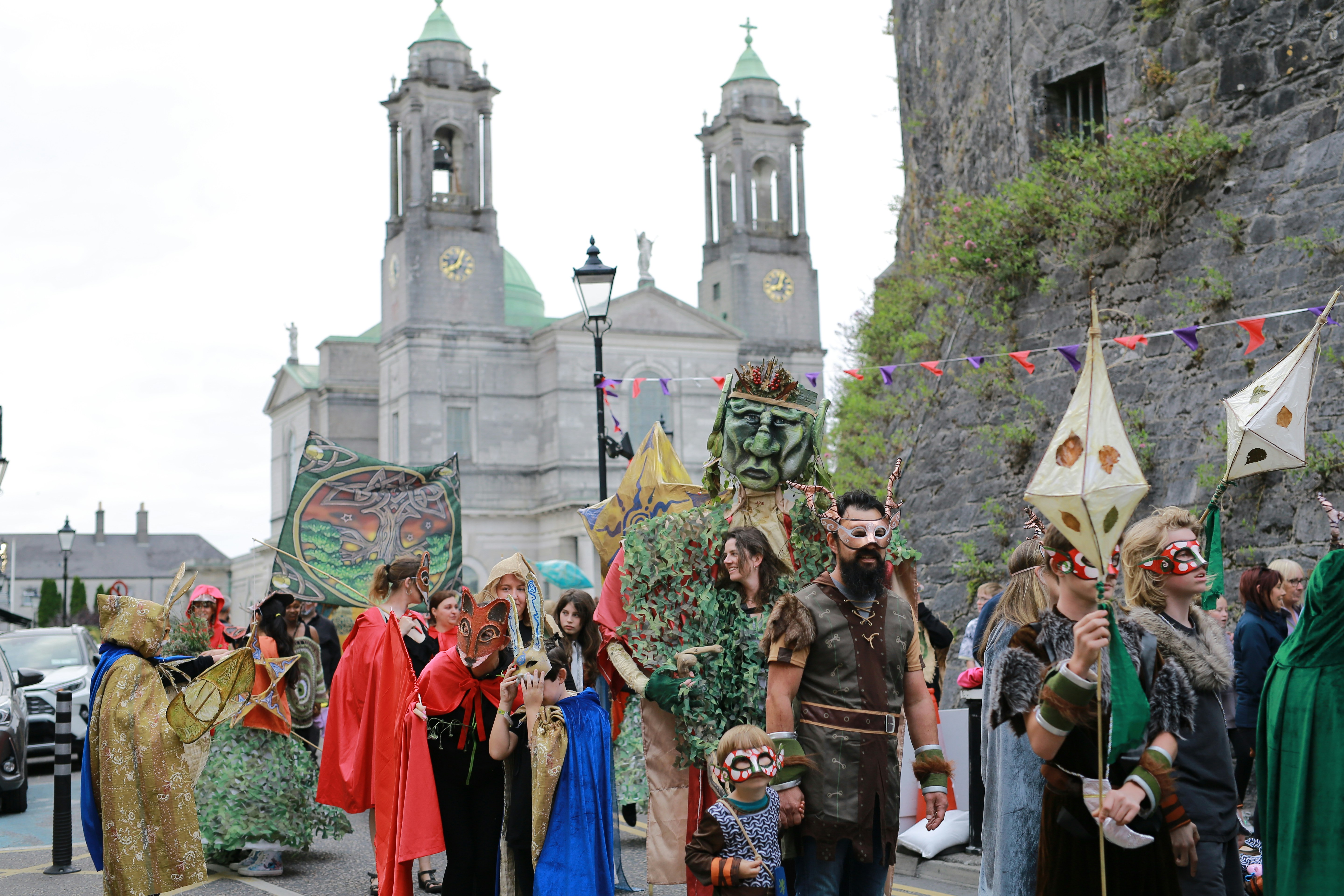 People in costumes marching in a street parade. photo – Free Banner ...