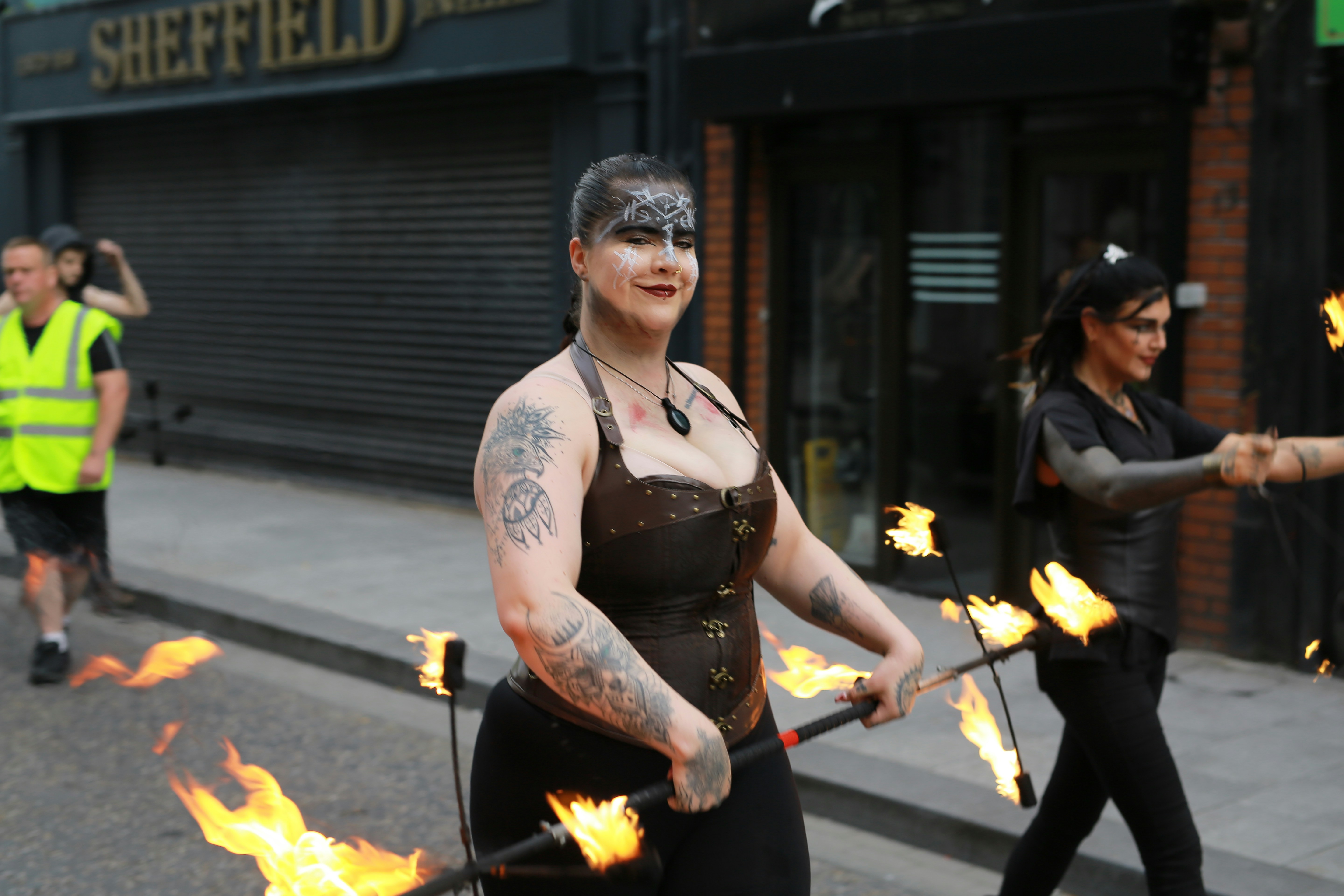 Fire and Velvet: A Tattooed Performer Leads the Street Flame
