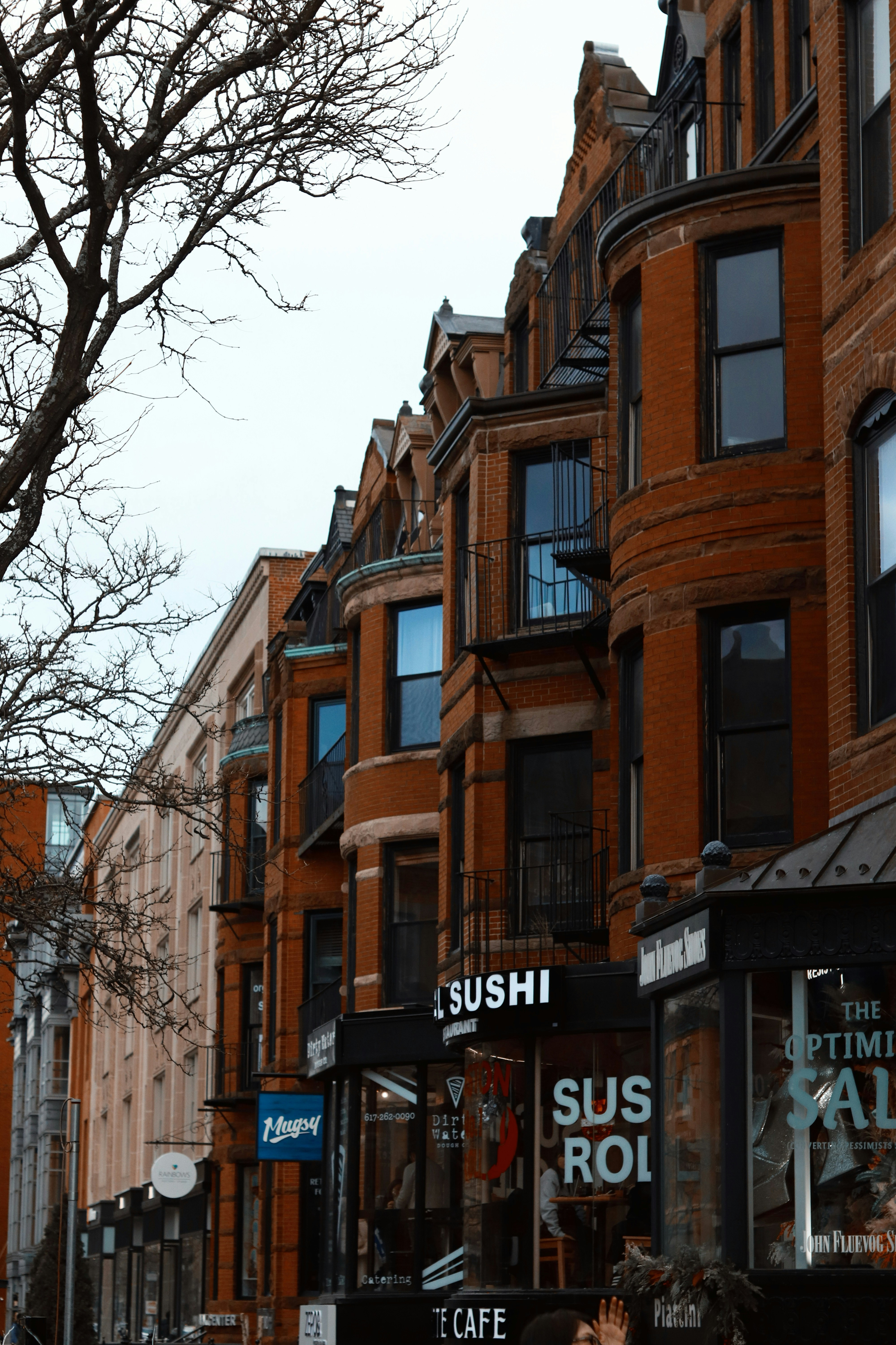 Row of brick buildings with shops on street level. photo – Free ...