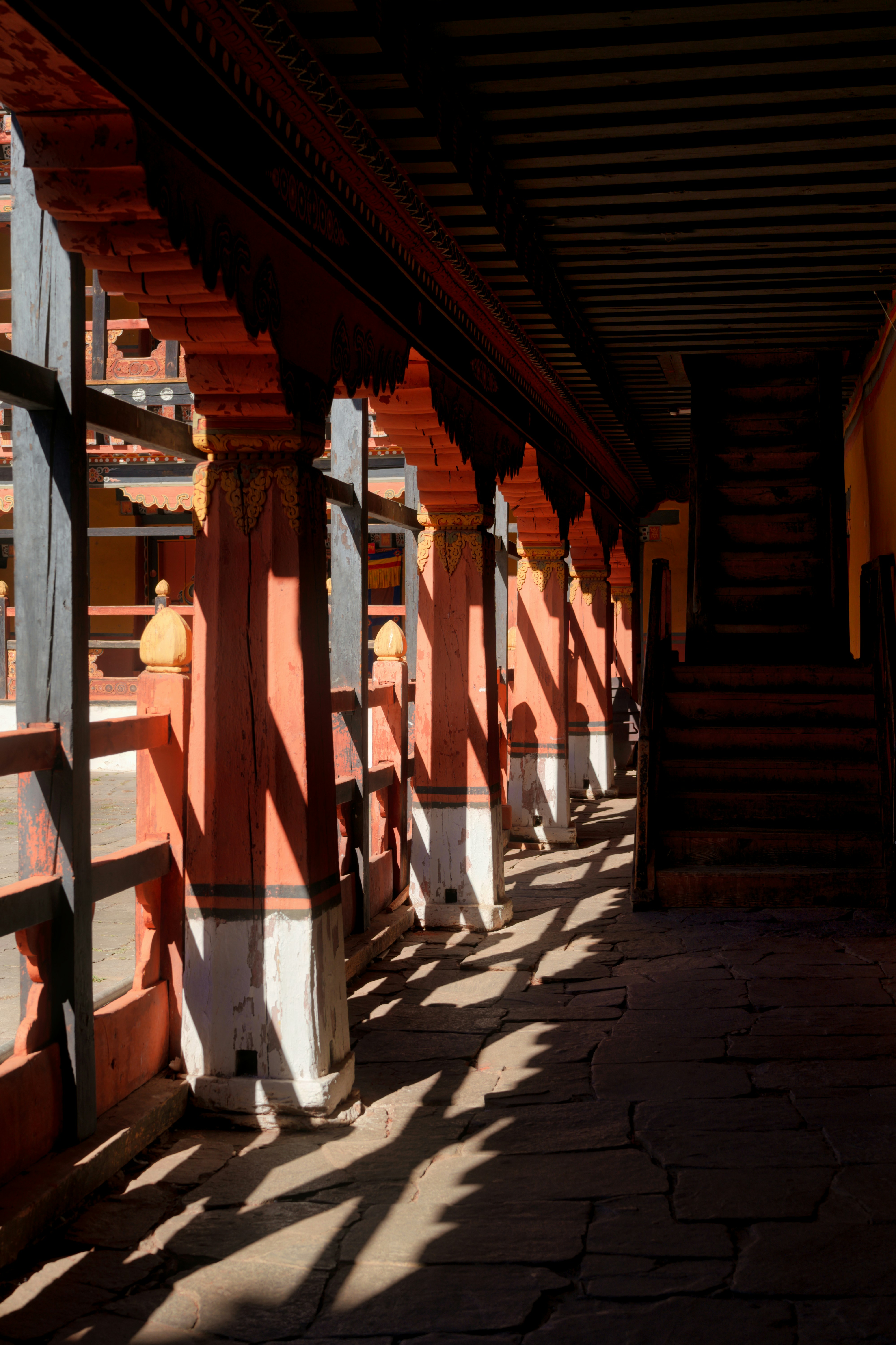 Shadowed Corridor of Painted Columns bathed in late sun