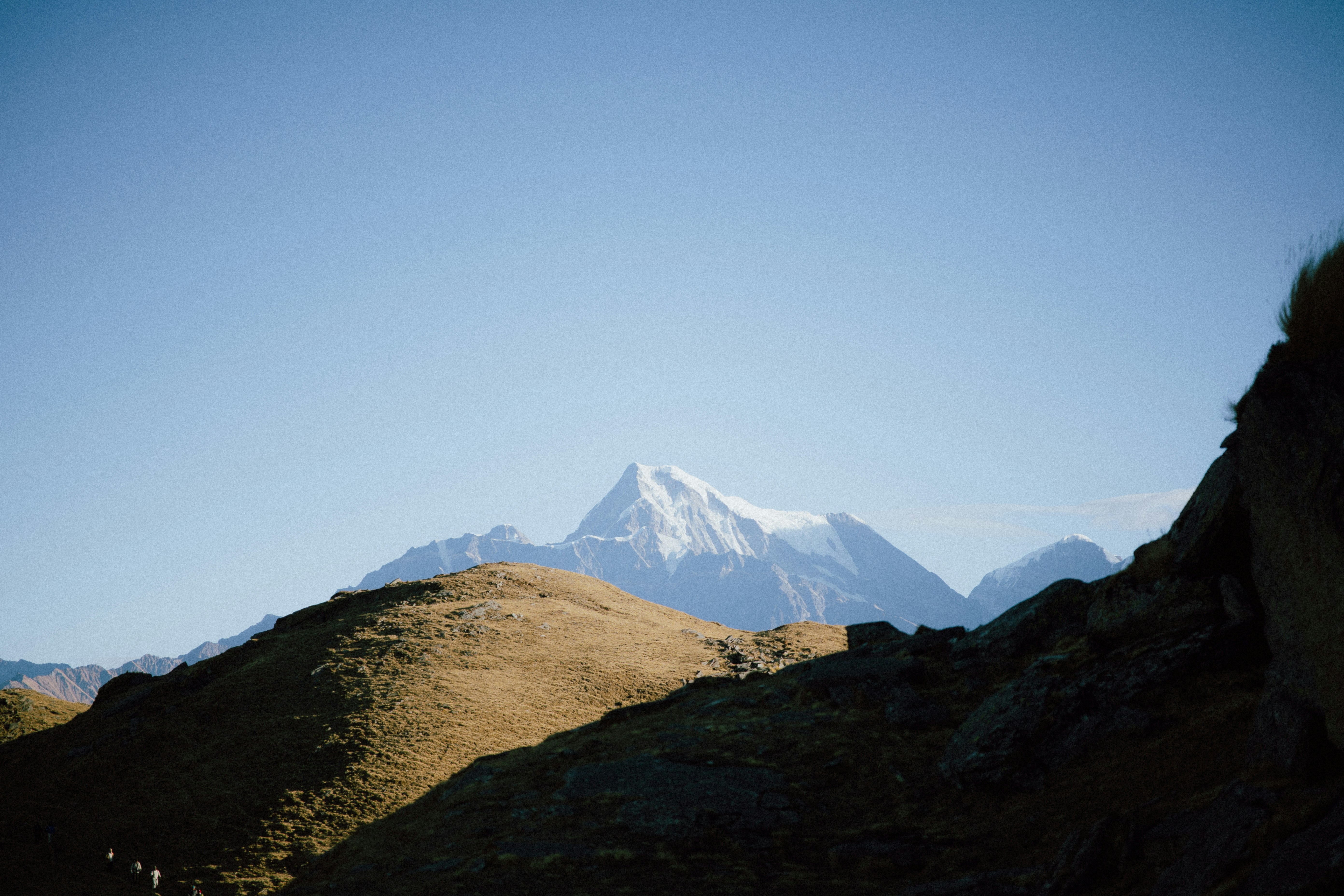 Snow-Capped Peak Rising Behind Warm Ridge