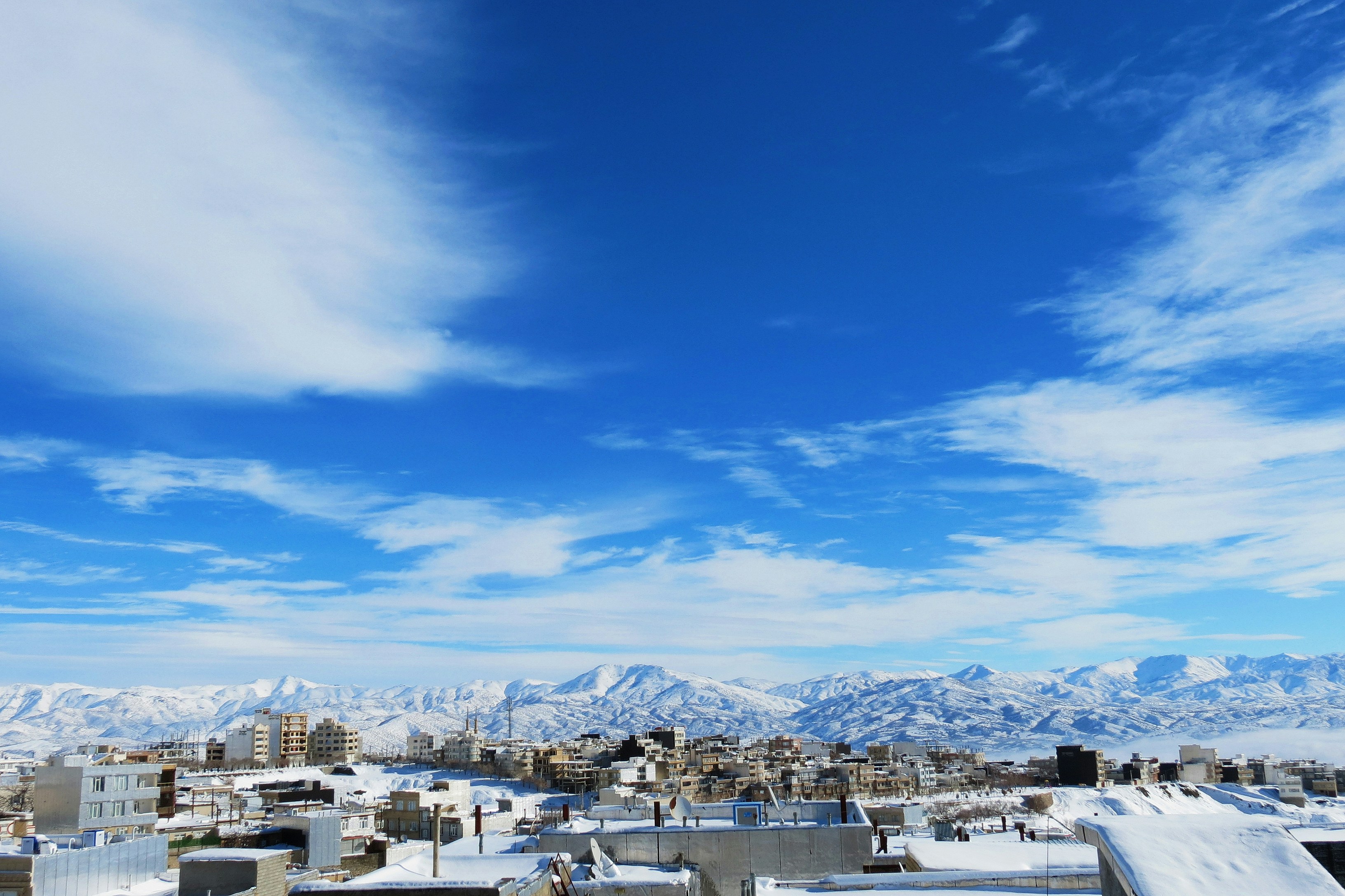 Snow-topped cityscape beneath a crisp alpine sky