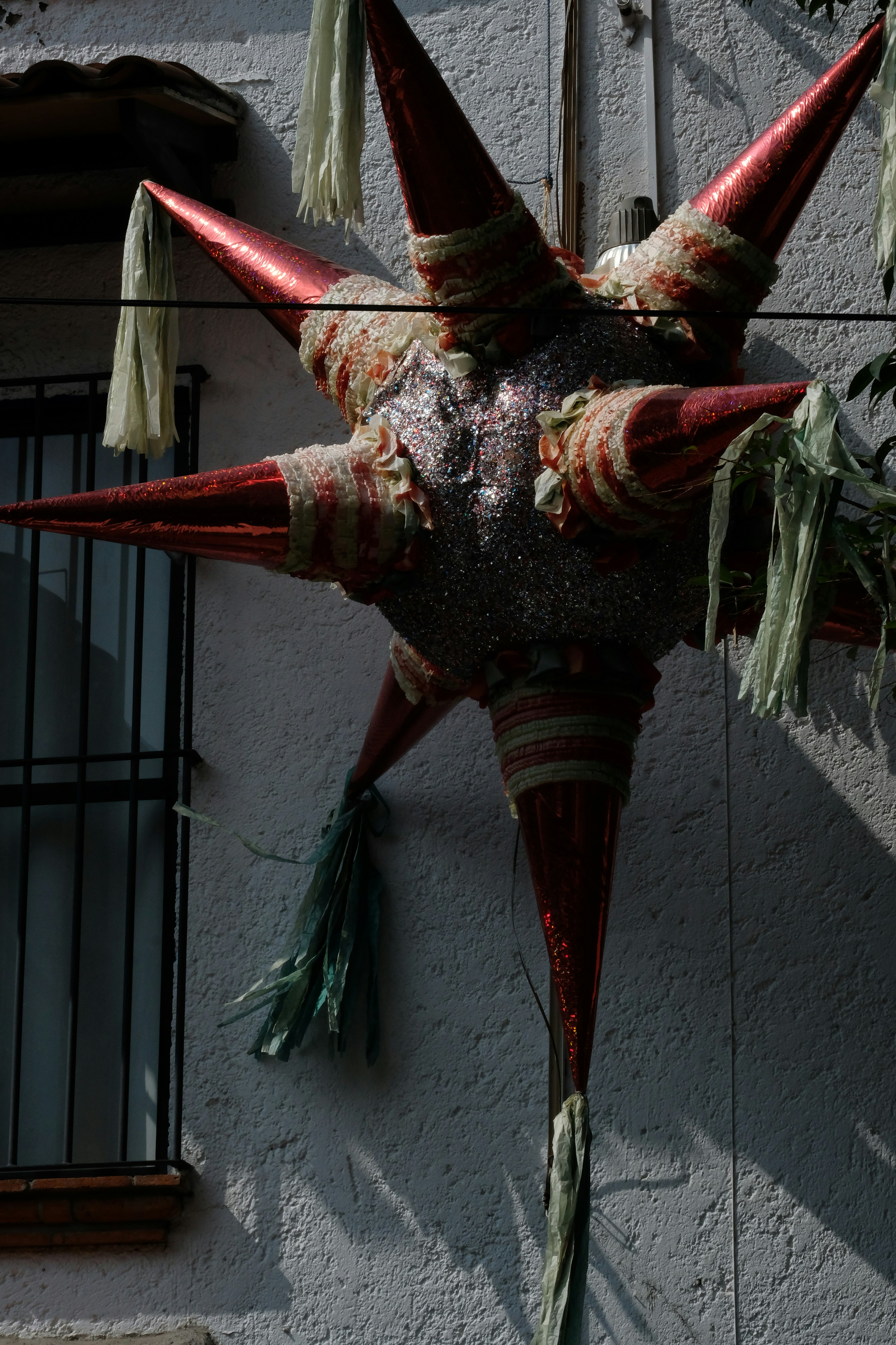 Star of decay: a weathered ceremonial star fixed to a textured wall