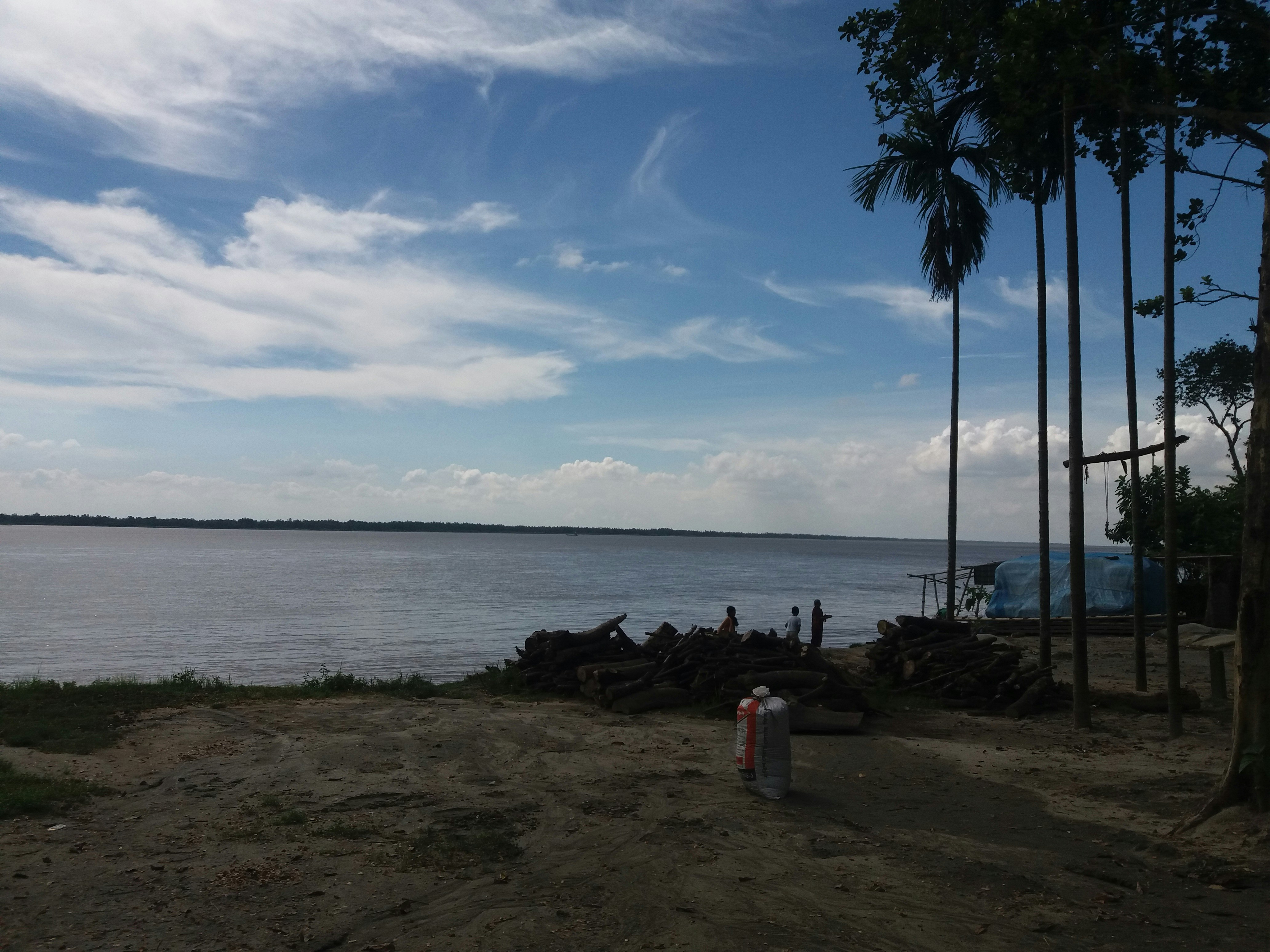 Lakeside Worksite Under a Cotton-Cloud Sky