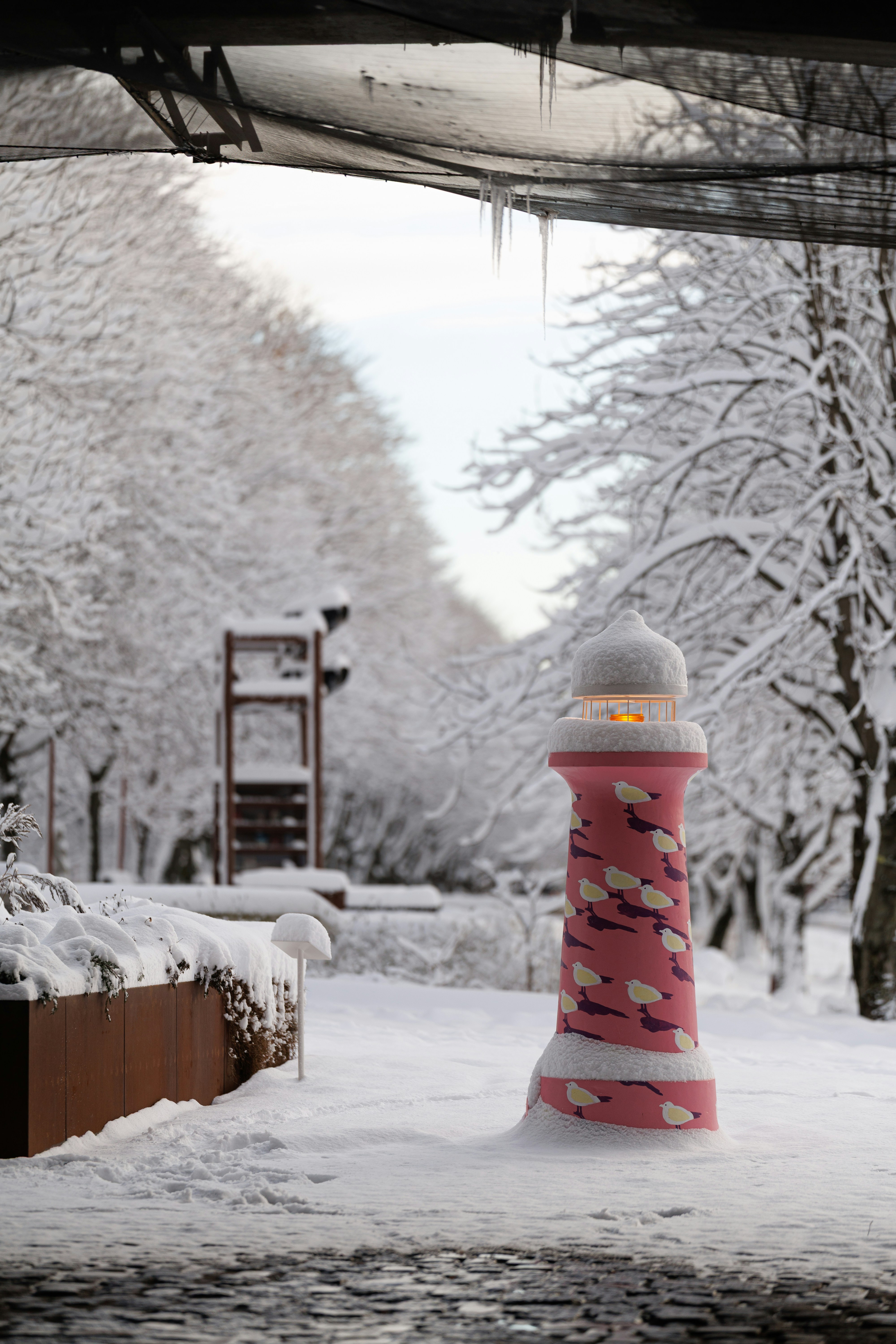 Snowy Park Lantern: A Pink Post in Quiet Winter Light
