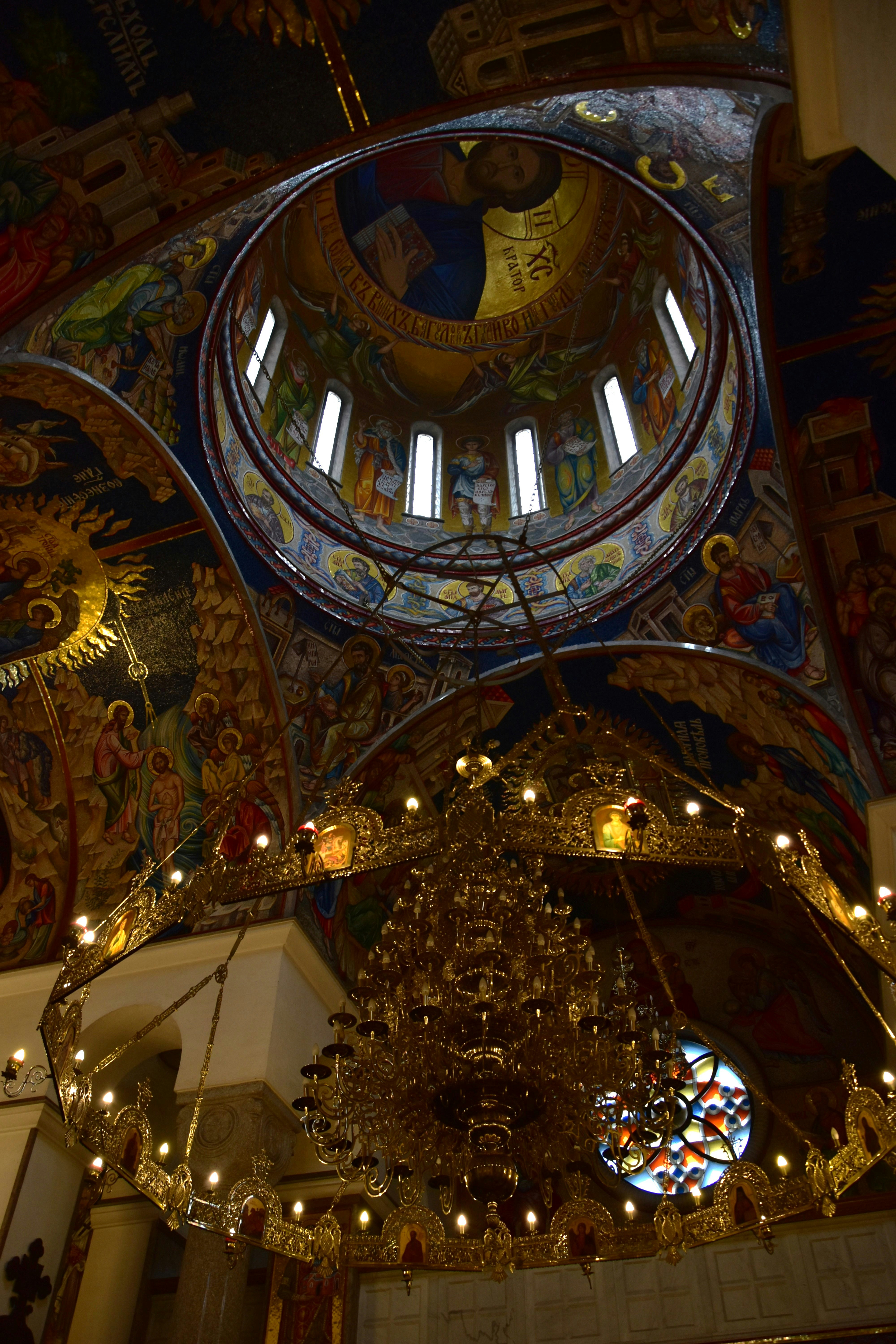Celestial Dome of Icons: A Haloed Interior with Golden Chandeliers