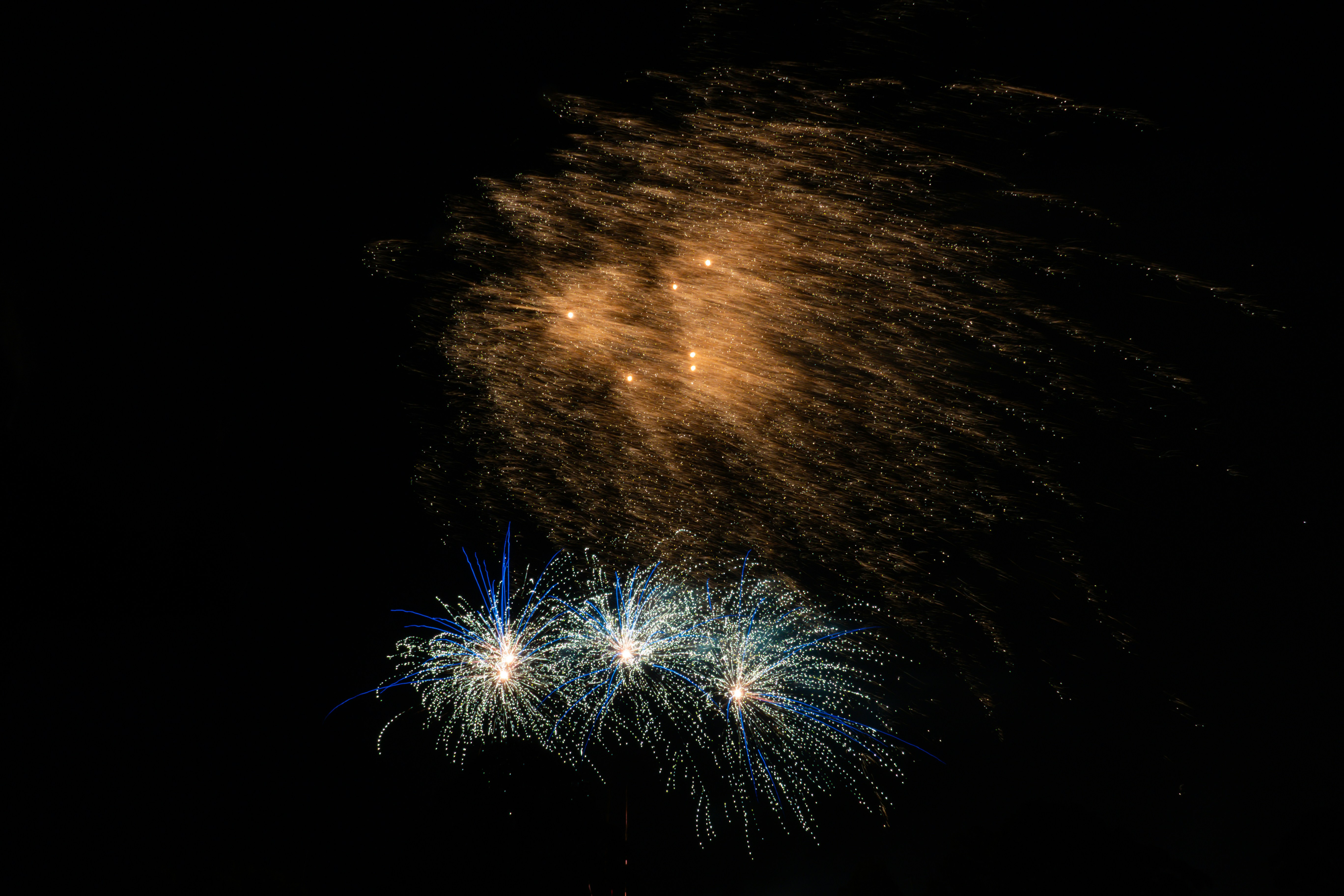 Blue Fireworks Bloom Over Night Sky