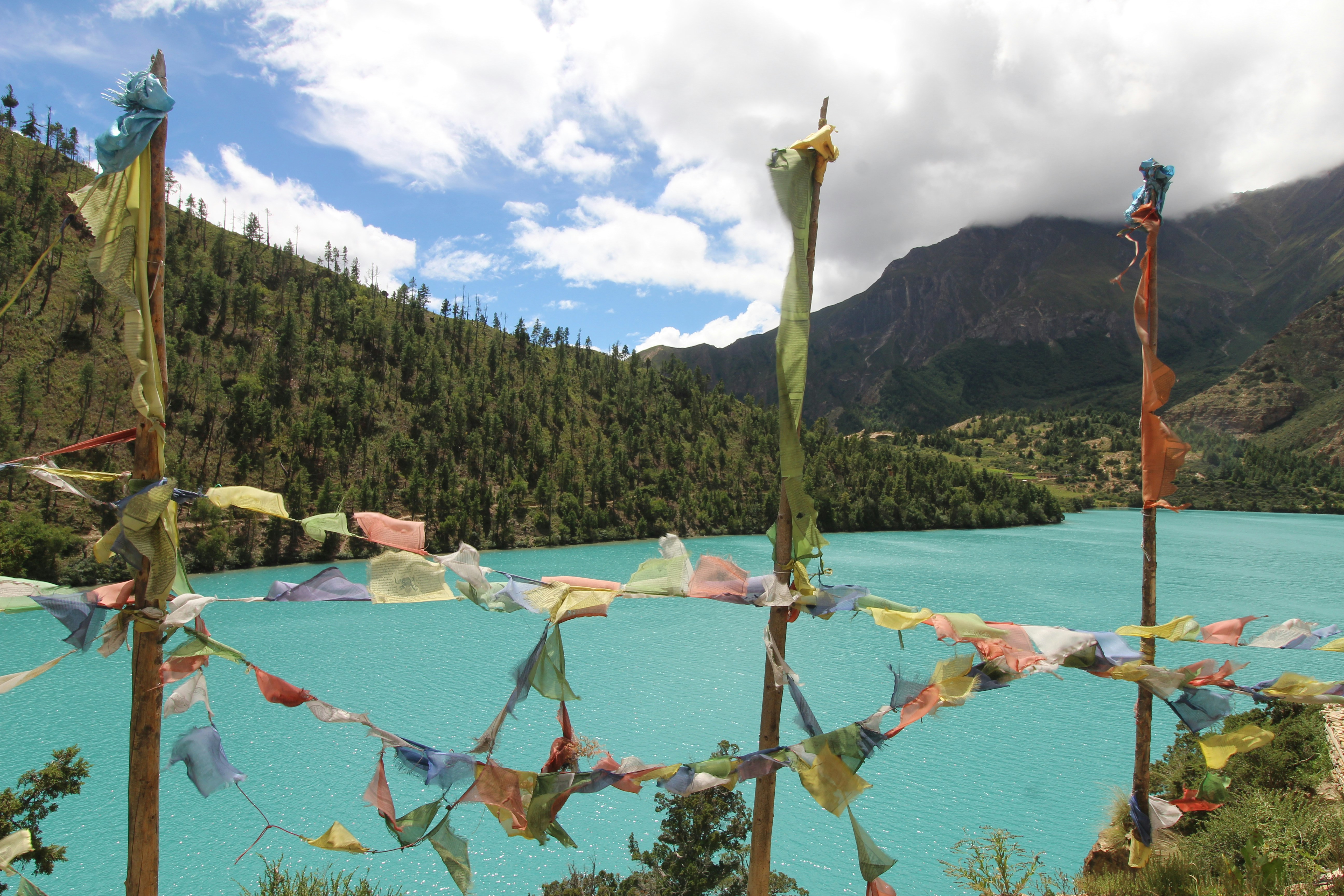 Pristine Turquoise Basin Under Prayer Flags