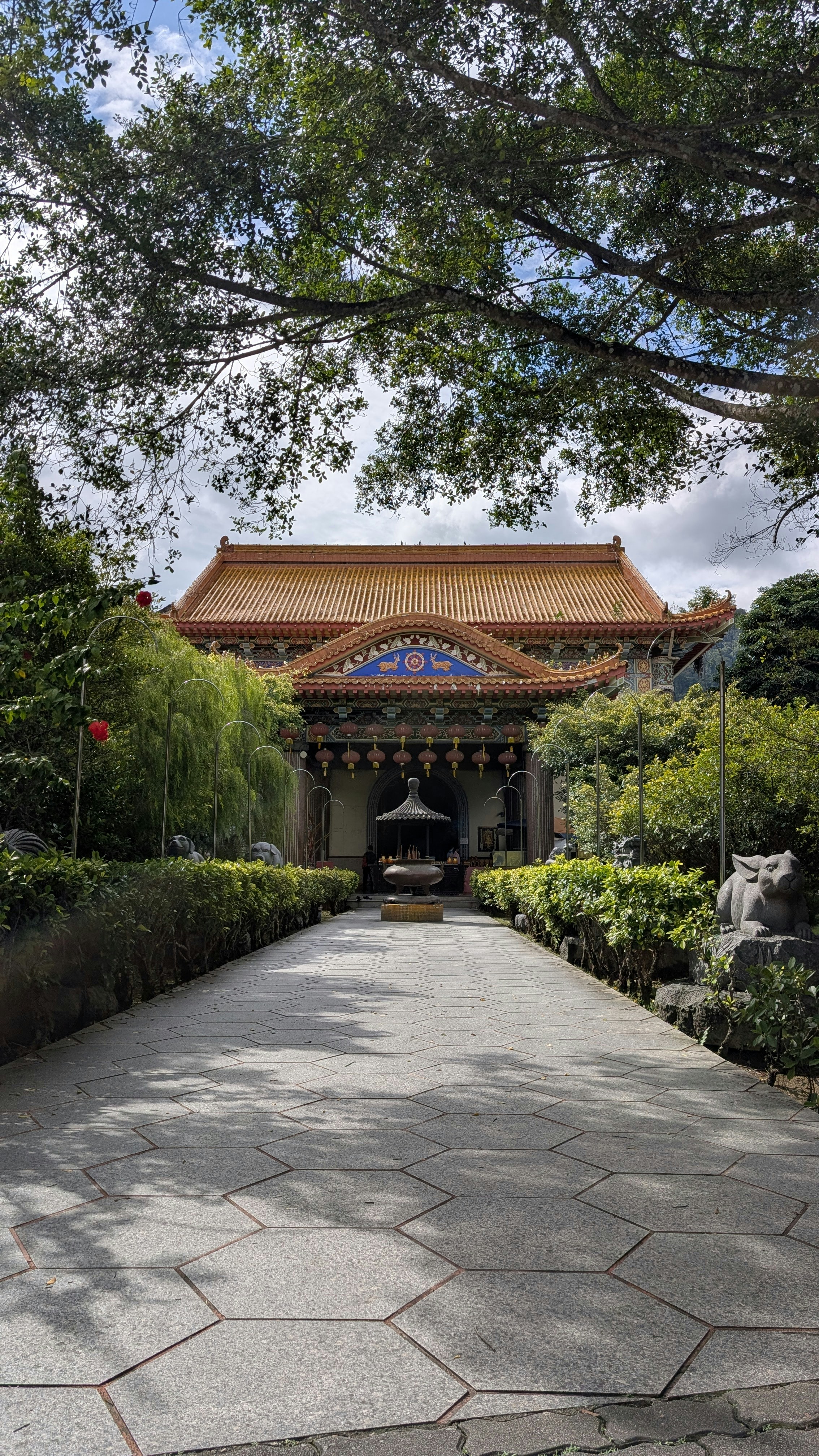 Path leading to a traditional building with ornate roof.