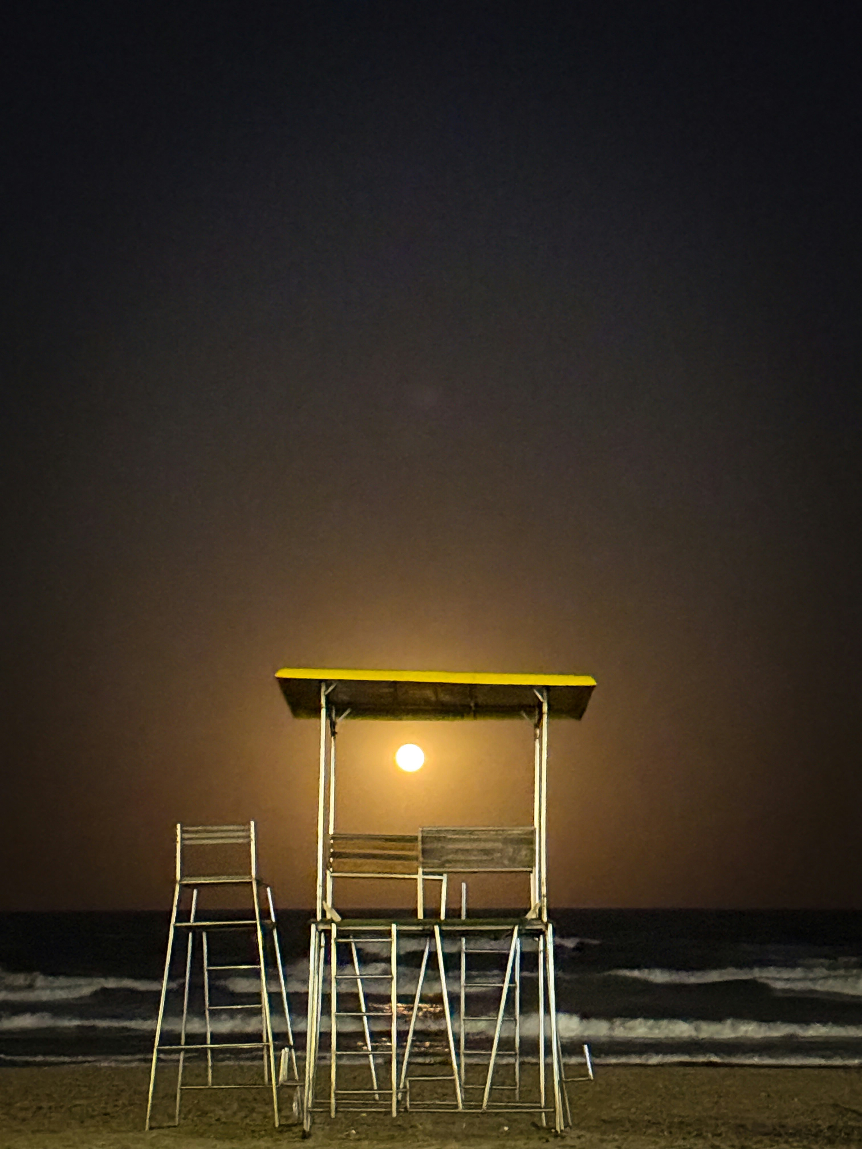 Lifeguard Tower Beneath a Moonlit Horizon