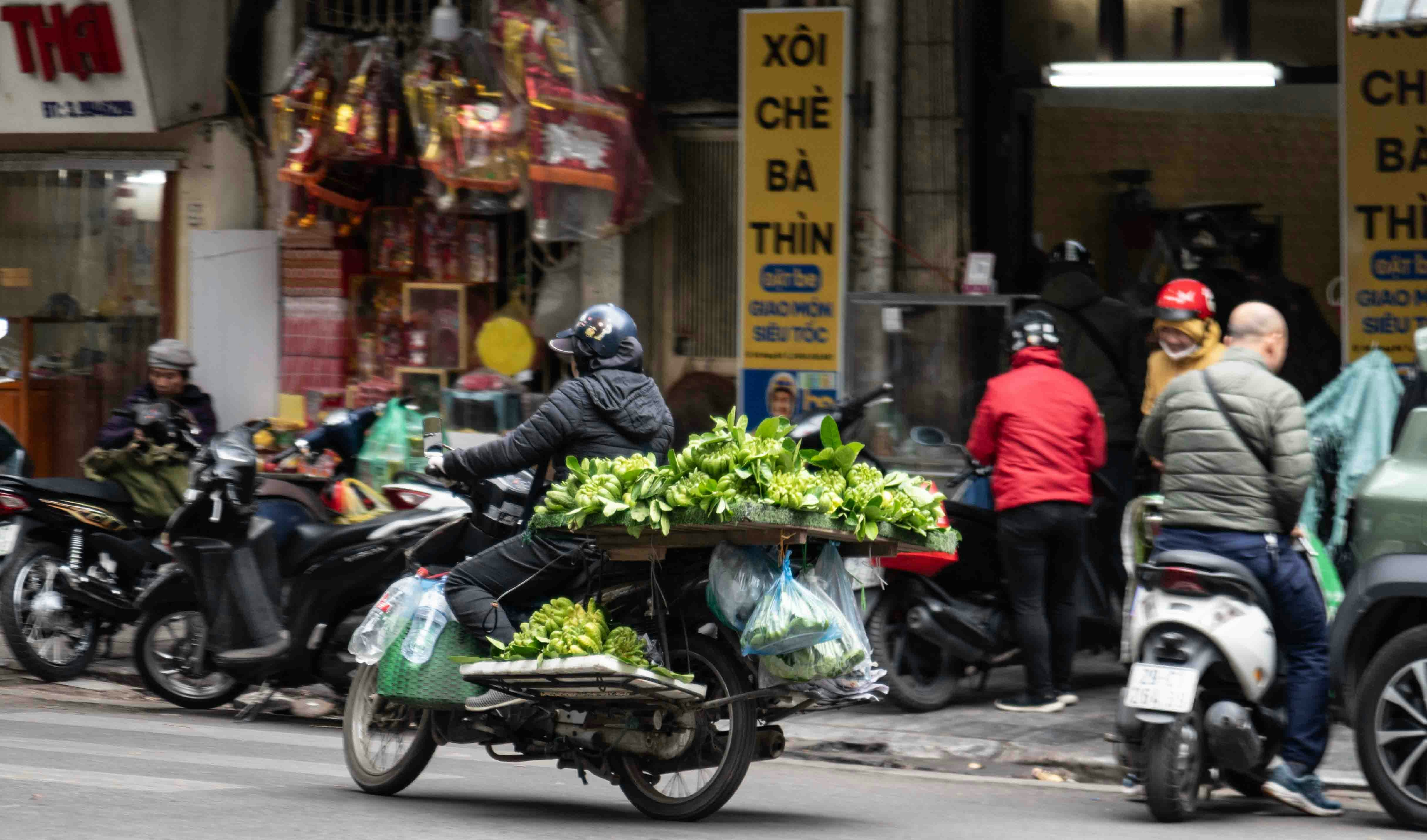 Street Vendor Cart Brimming with Greens Anchors a Bustling Market Scene