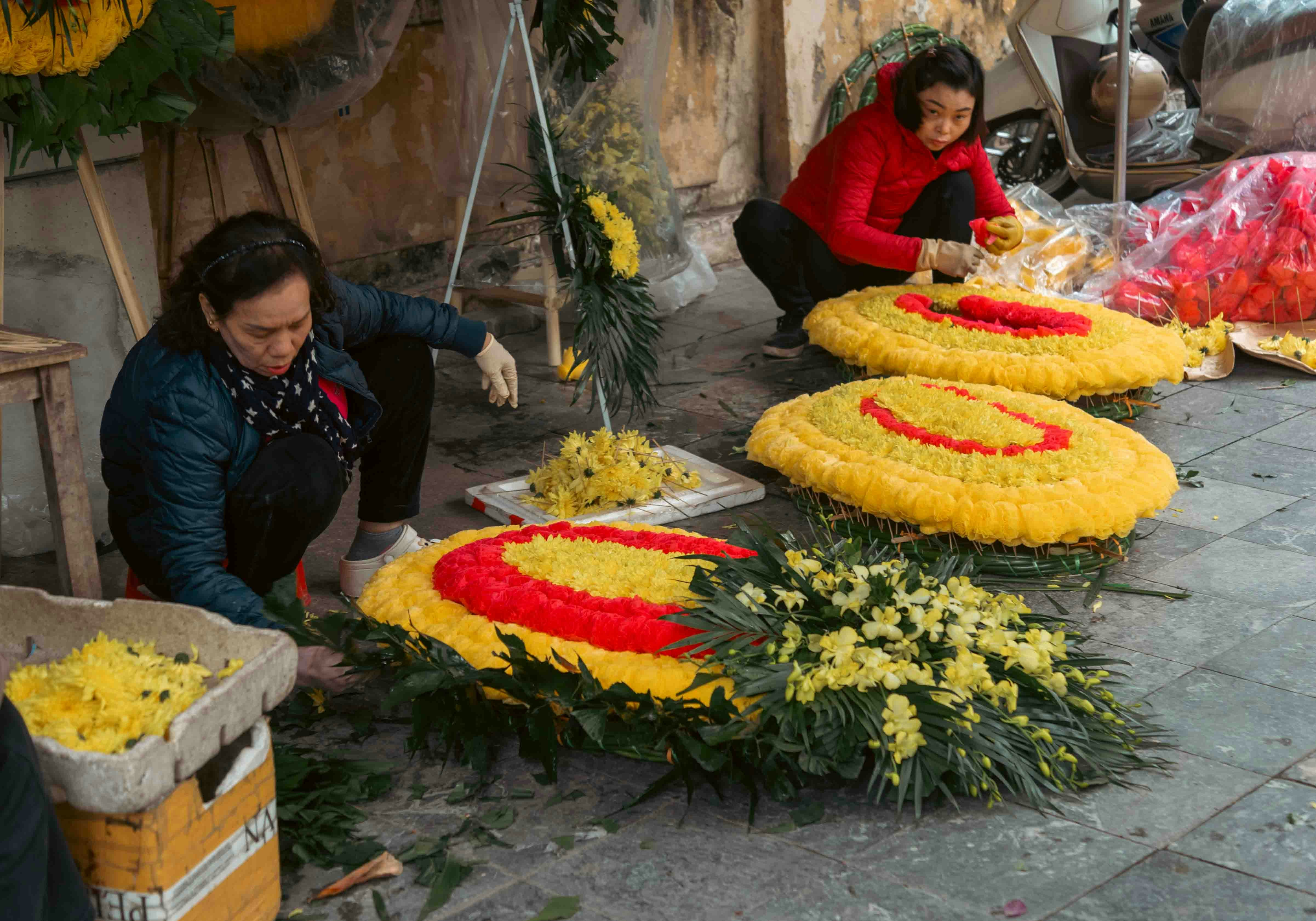 Wreath Makers at Dawn: Yellow Petal Circles on a Stone Courtyard