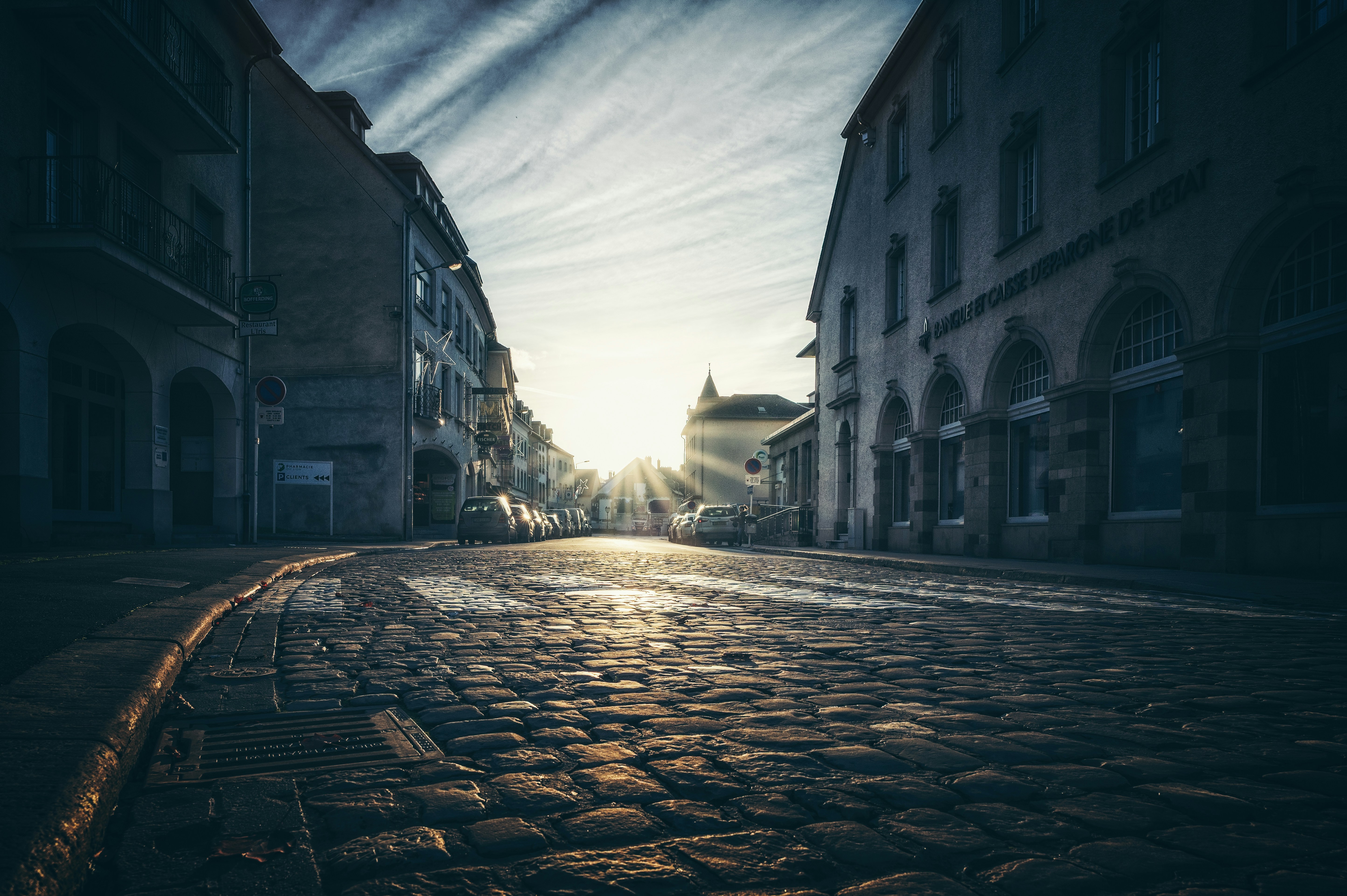 Dawn Over Cobblestones: Street Leading to a Bright Vanishing Point
