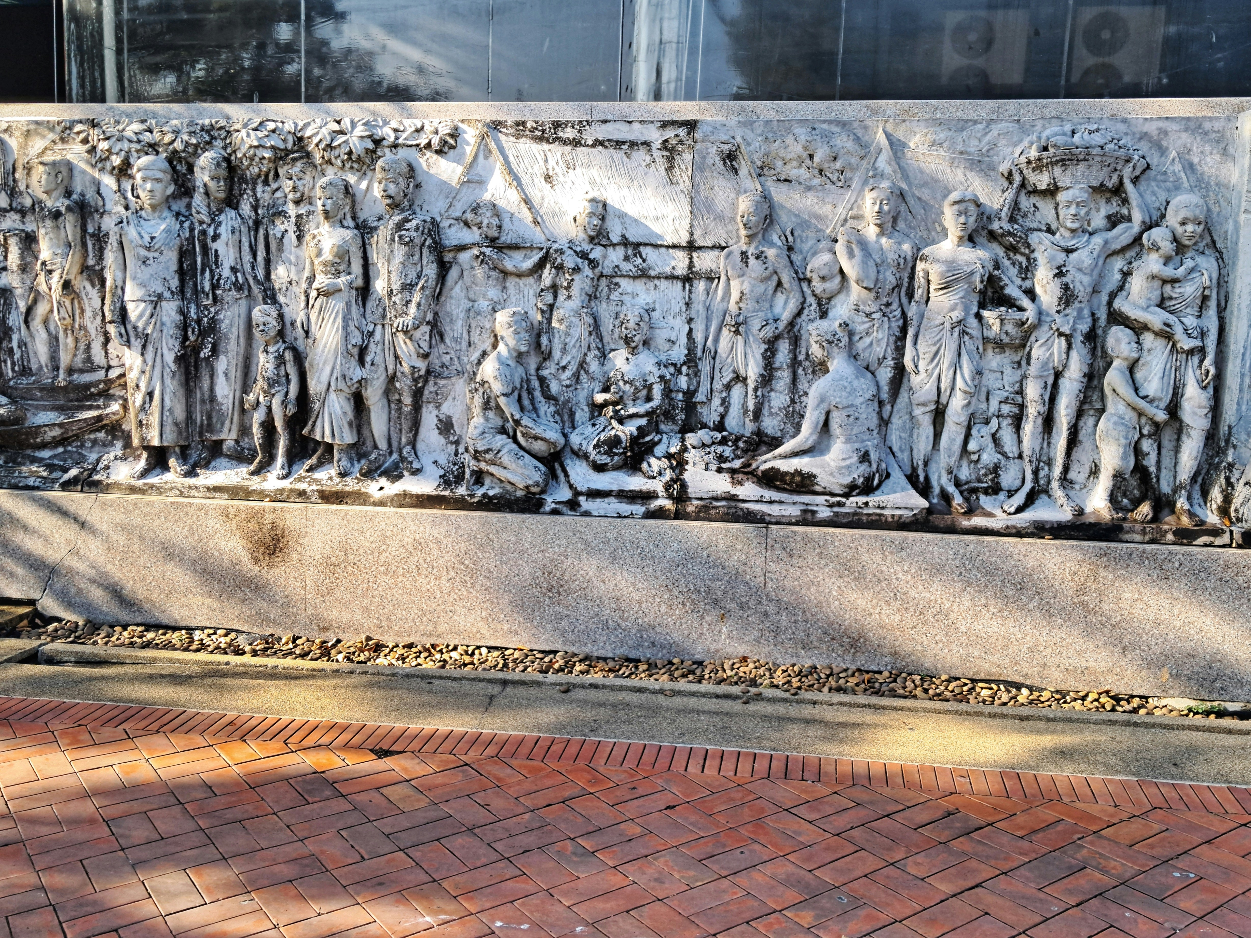 Stone relief sculpture depicting a historical scene with many figures.