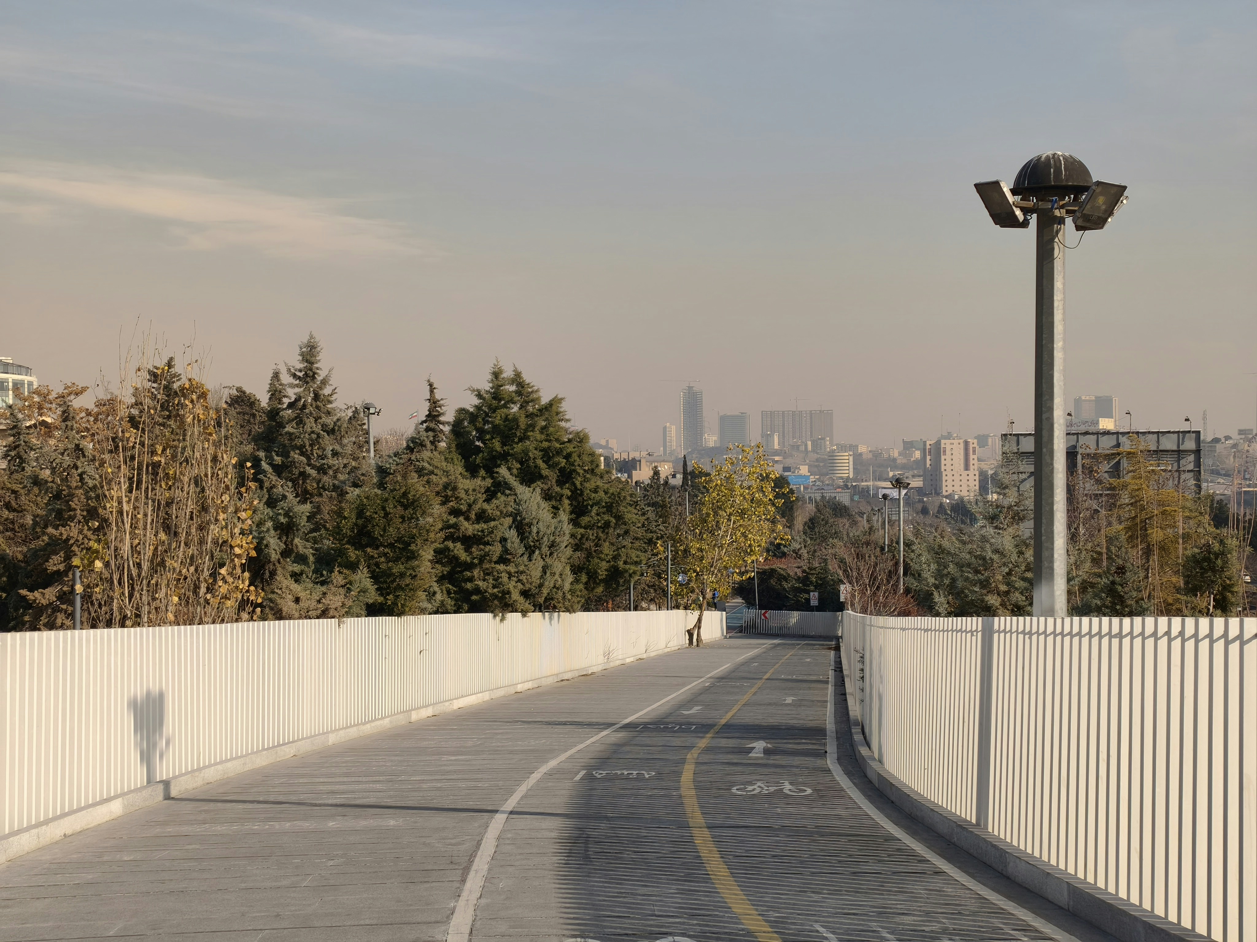 A paved path with a city skyline in the distance