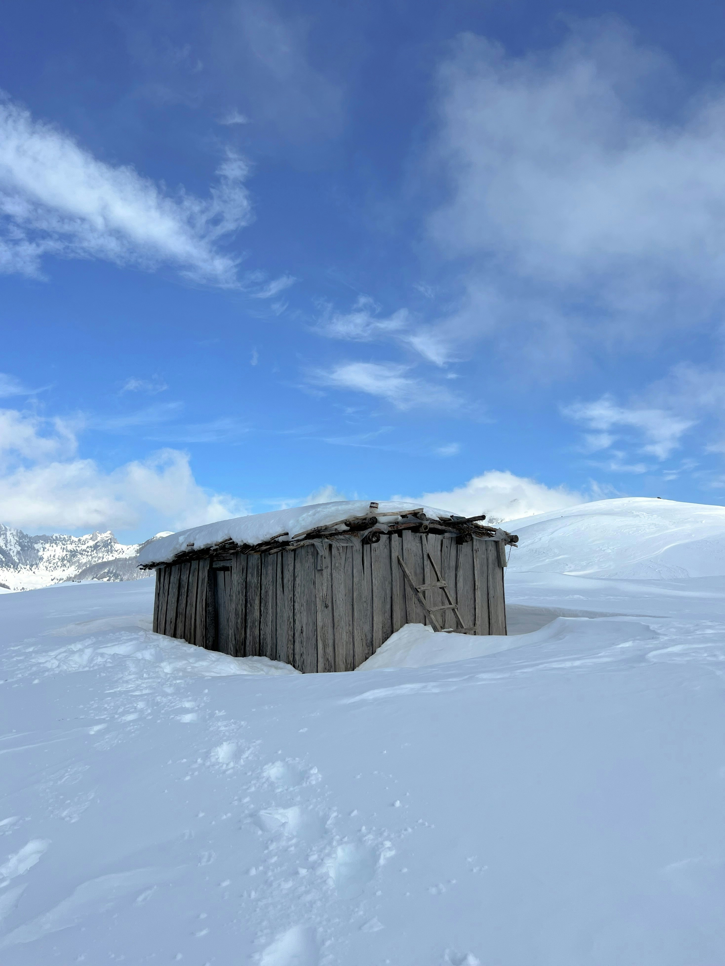 Snowbound Cabin Under Expansive Blue Sky