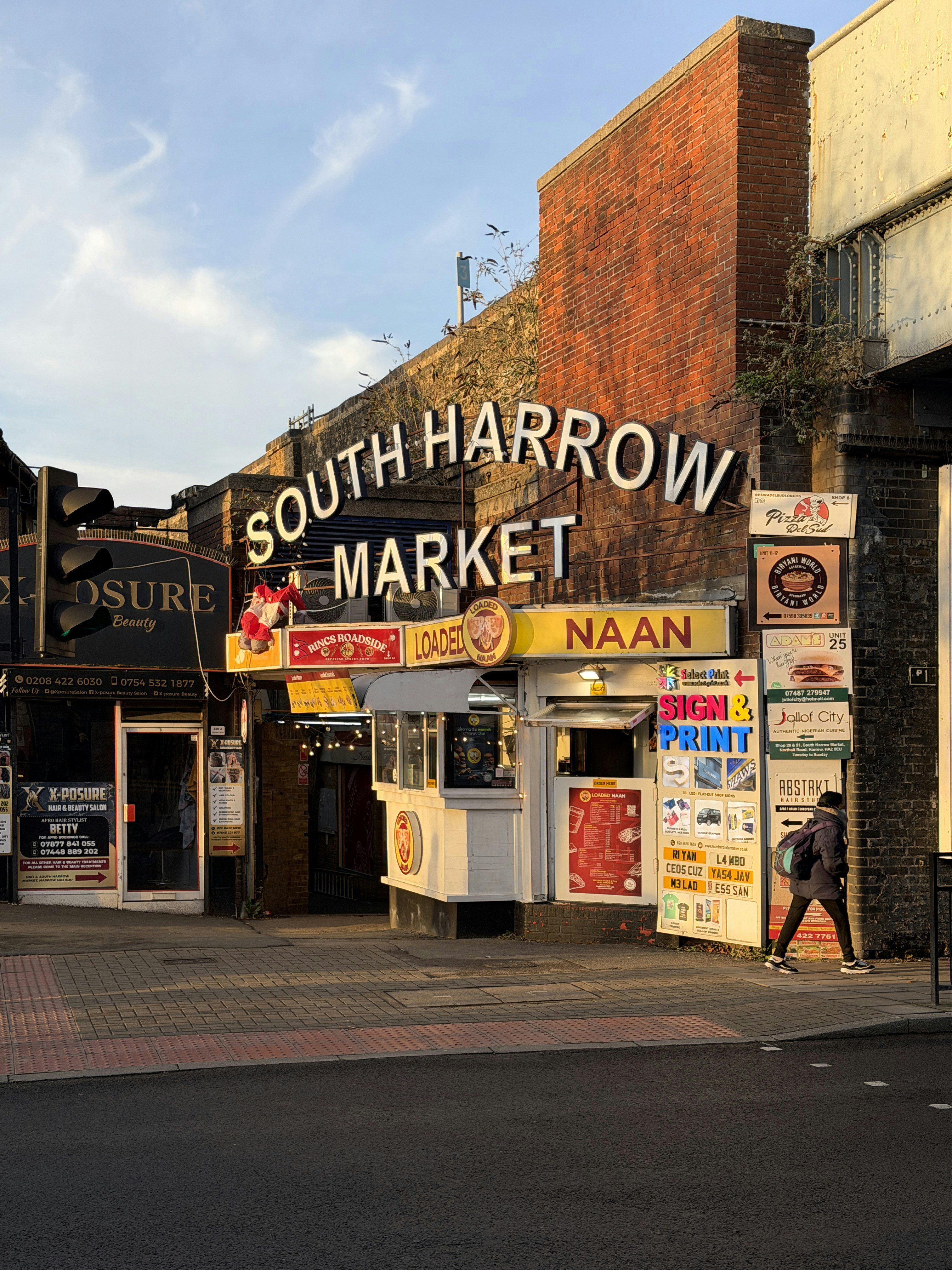 South harrow market with shops and a person walking photo – Free Pizza ...