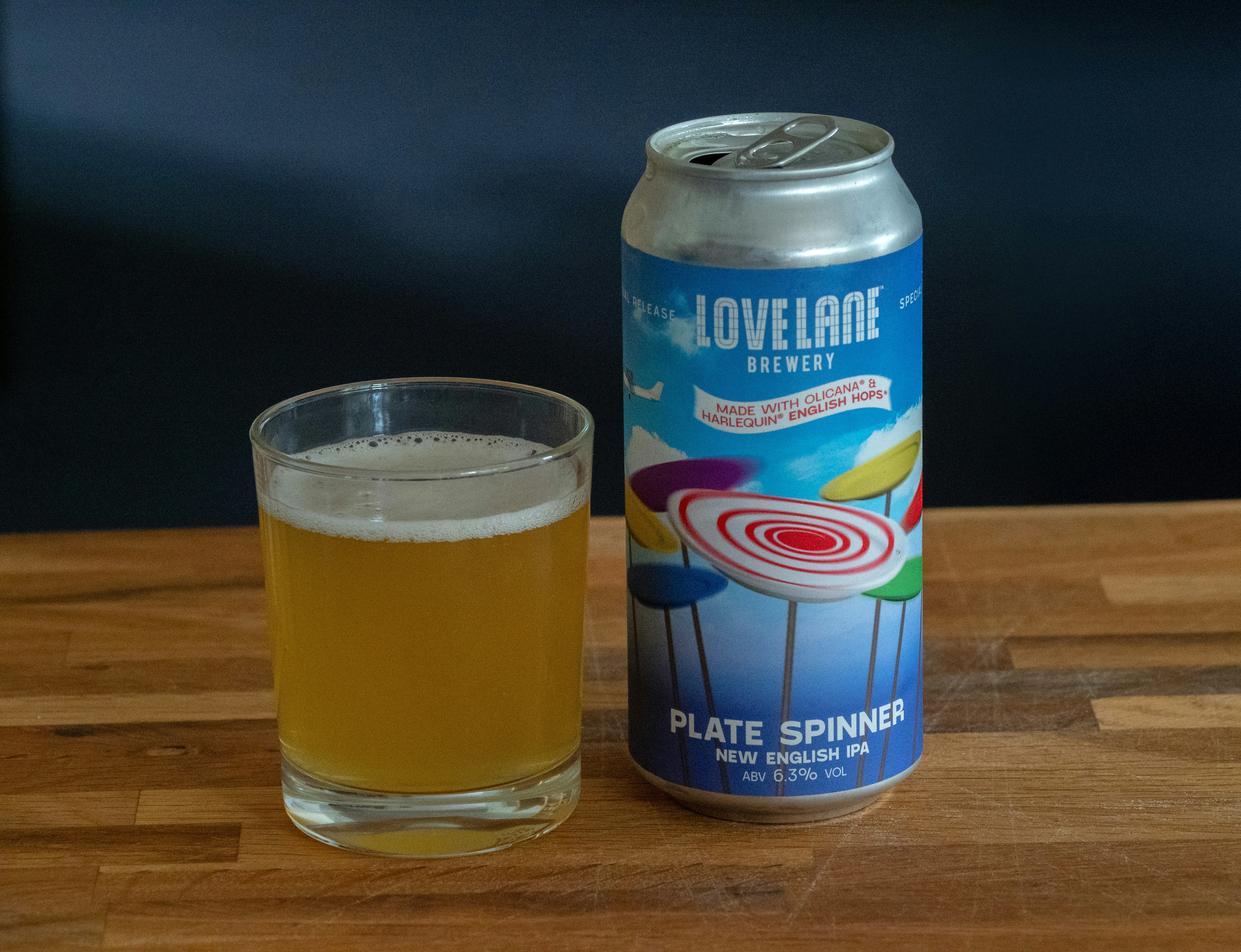 A Crisp Brew: Can and Glass on a Wooden Surface