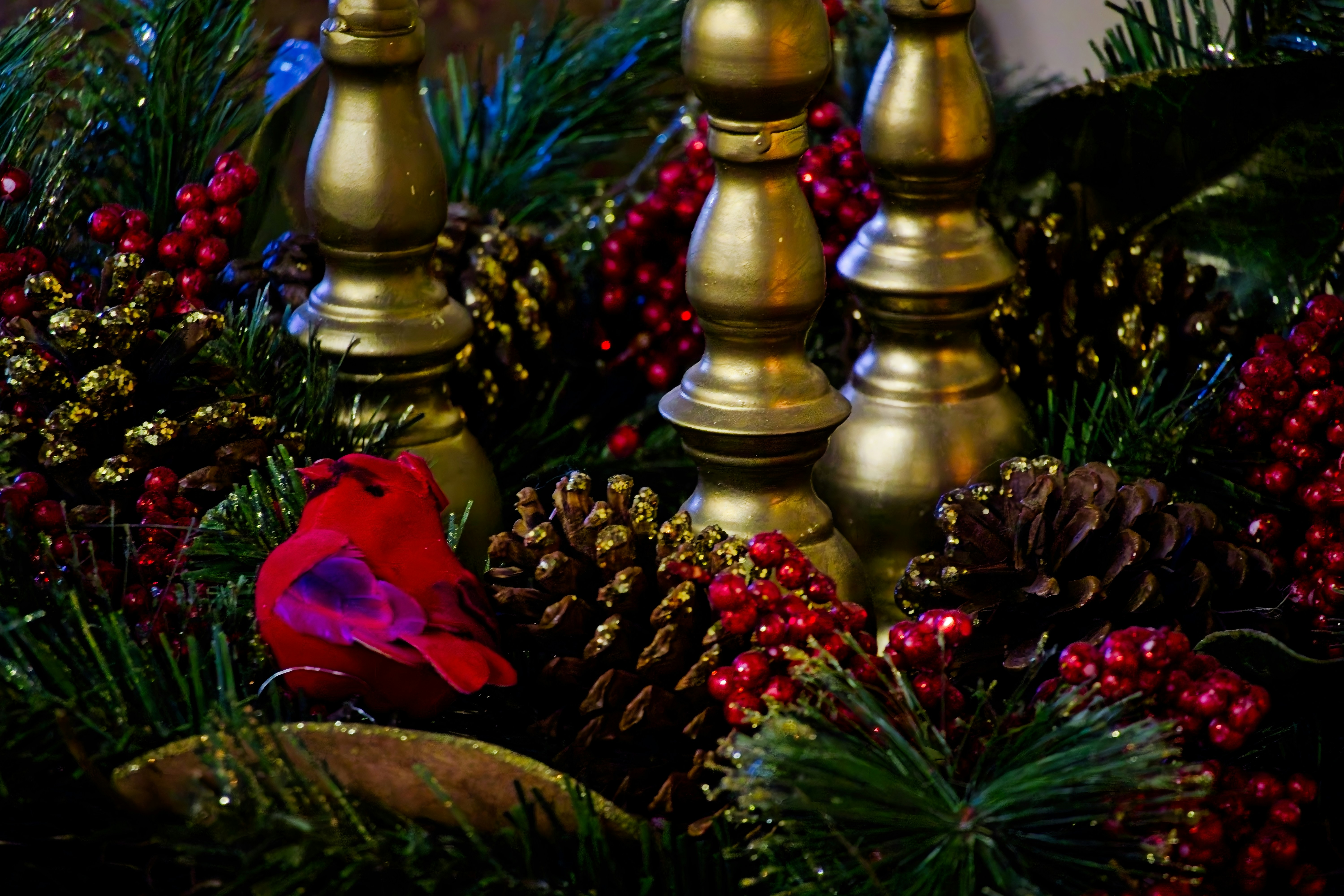 Candlelit Christmas Still Life: Pine Needles, Red Berries, and Golden Ornaments