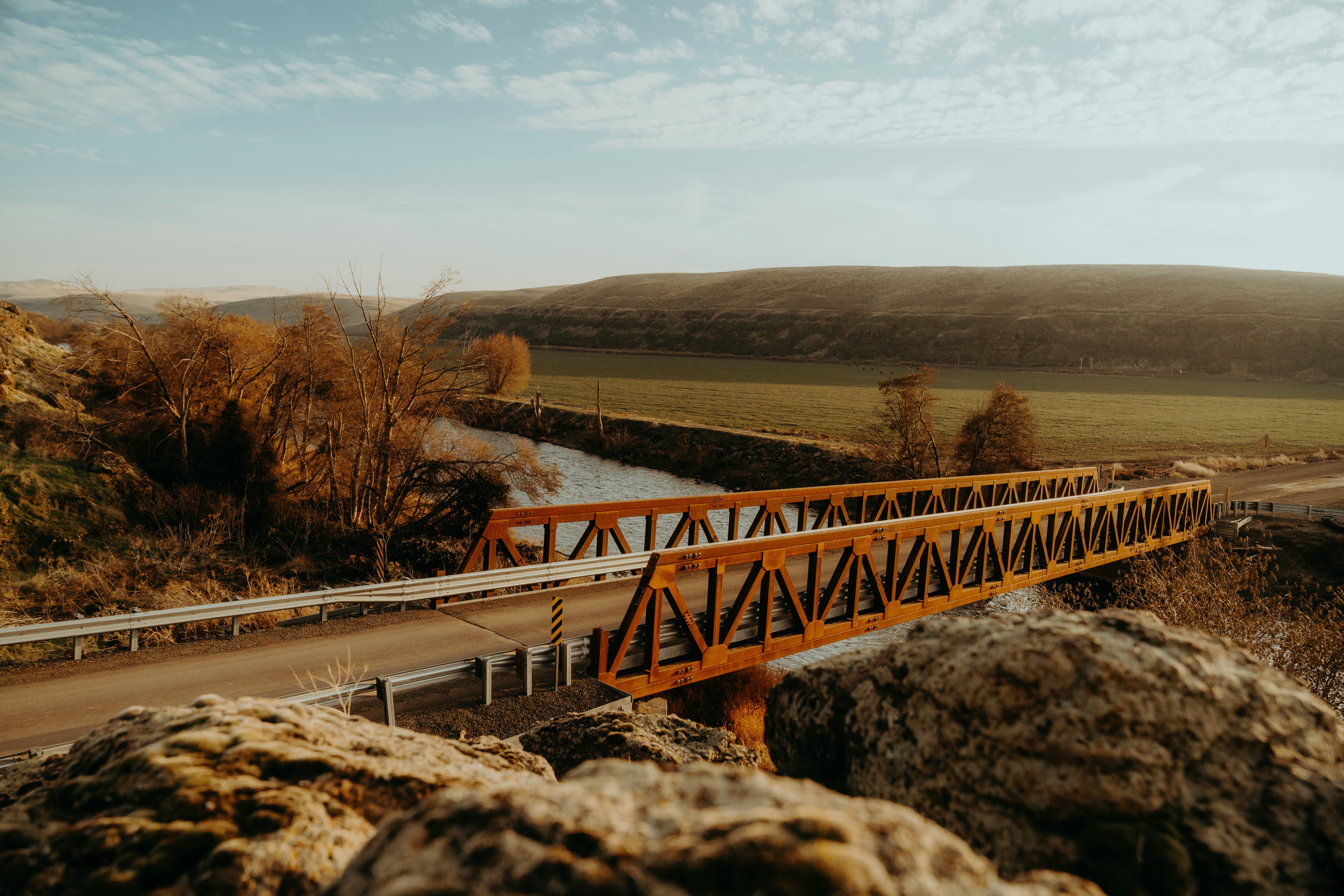 Iron Lattice over the River: Autumn Bridge at Dusk