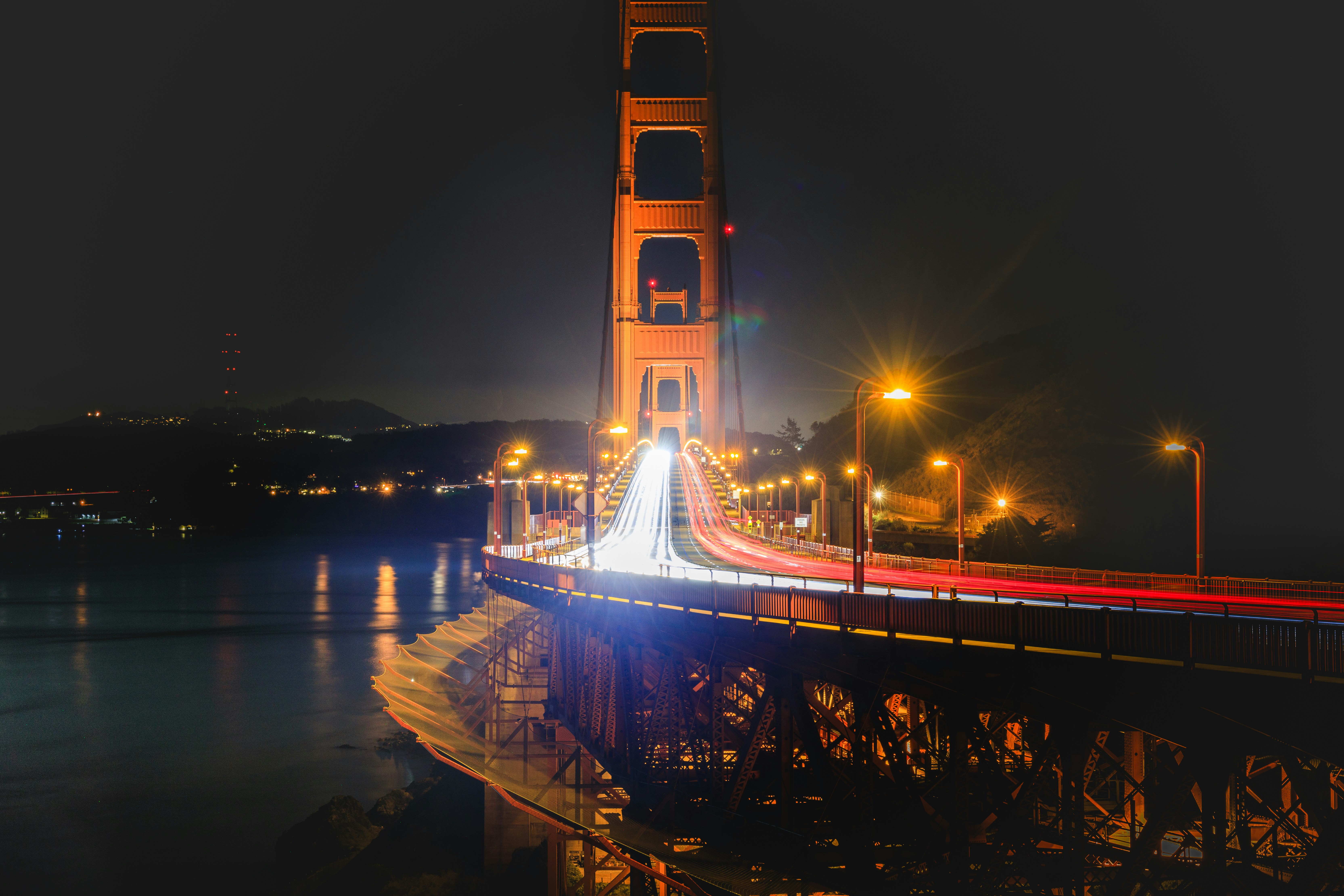 Nighttime Gateway: Golden Gate Bridge Bathed in City Glow