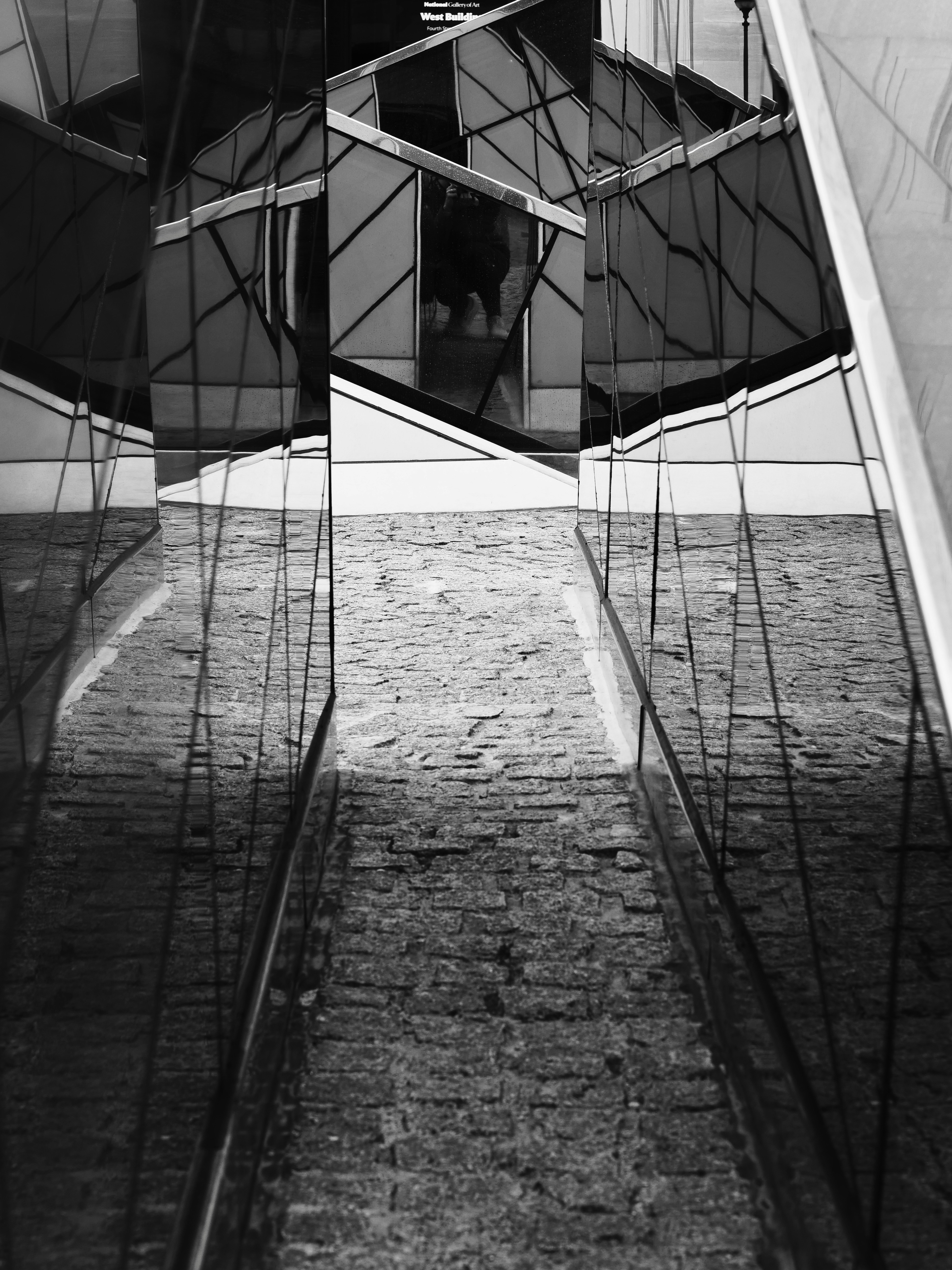 Mirrored Alley: Reflections Converge on a Narrow Canyon of Glass