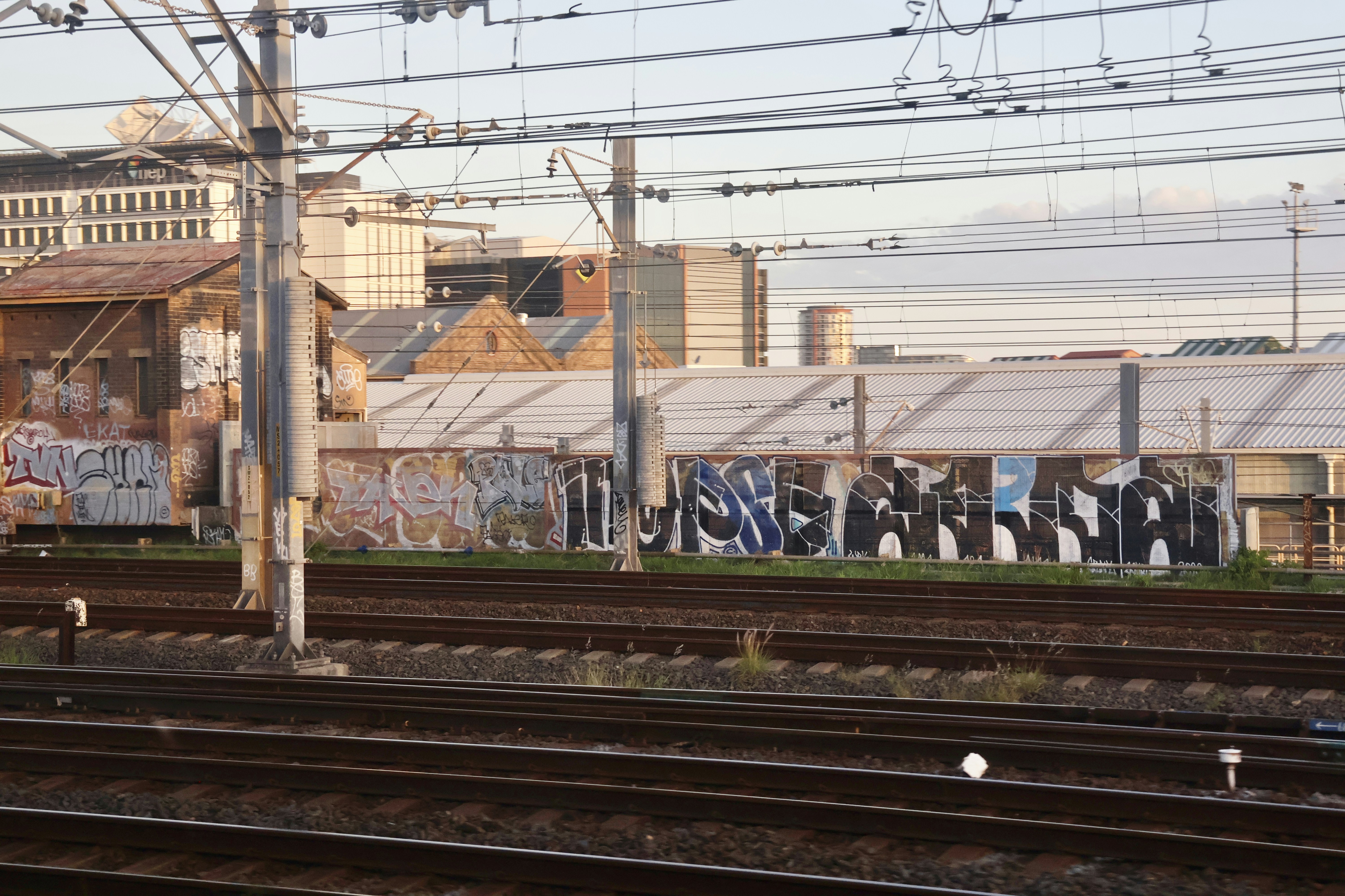 Graffiti-Decorated Freight Train Yard at Dusk