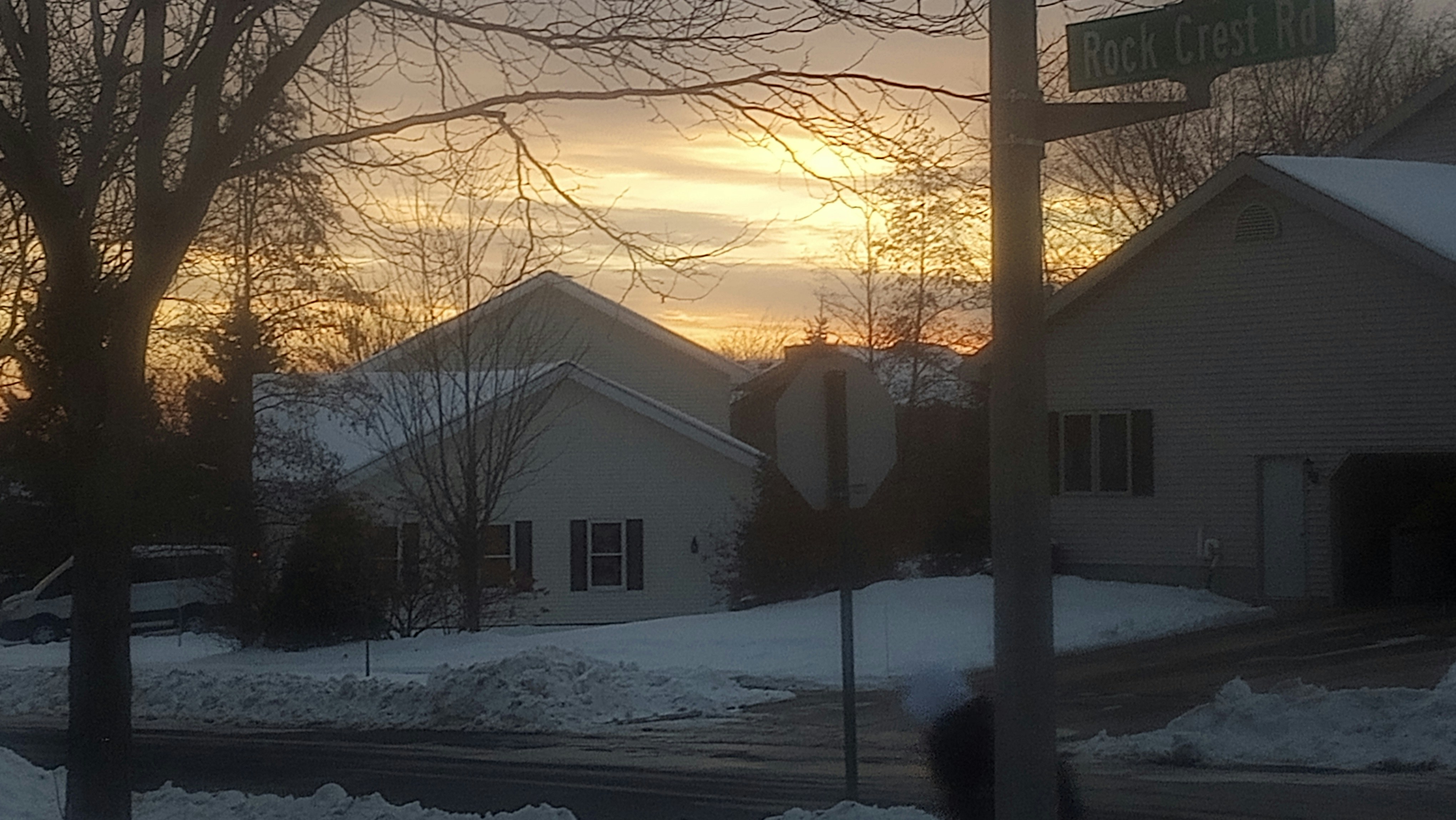 Sunset Over Suburban Snow, Silhouetted Homes at an Intersection